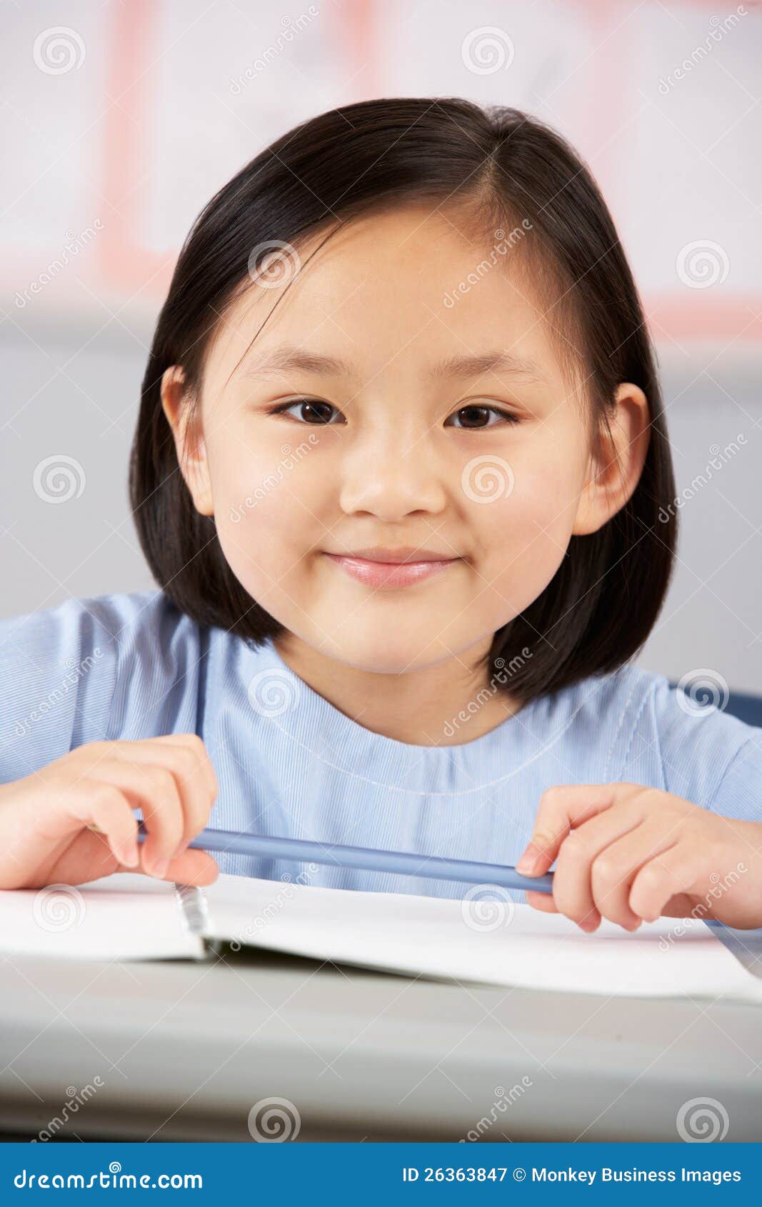 Female Student Working at Desk in School Stock Image - Image of sitting ...
