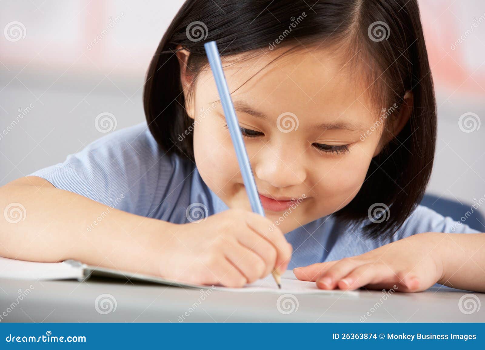 Female Student Working at Desk in School Stock Photo - Image of people ...
