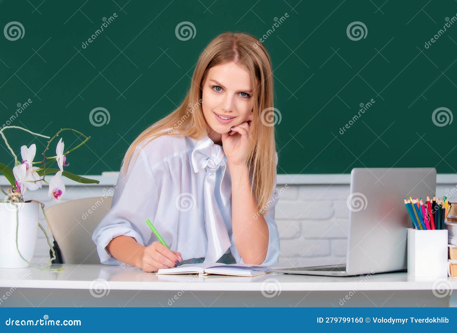 Female Student Writing on Lesson Lecture in Classroom at High School or ...