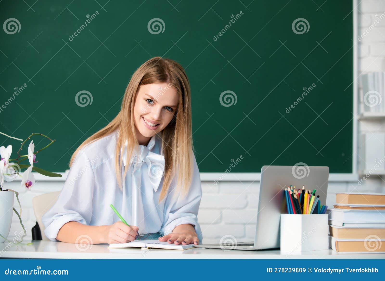Female Student Writing on Notebook on Lesson Lecture in Classroom at ...