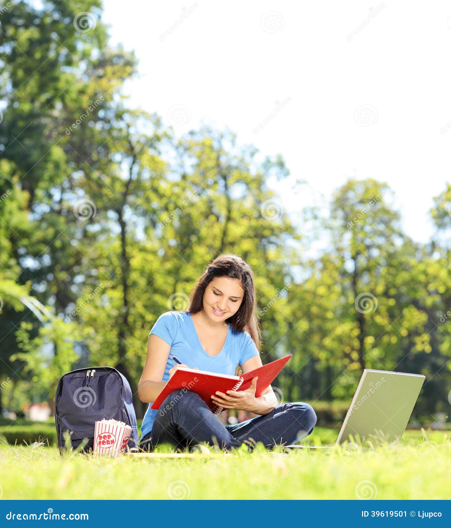 Female Student Writing in a Notebook Outdoors Stock Image - Image of ...