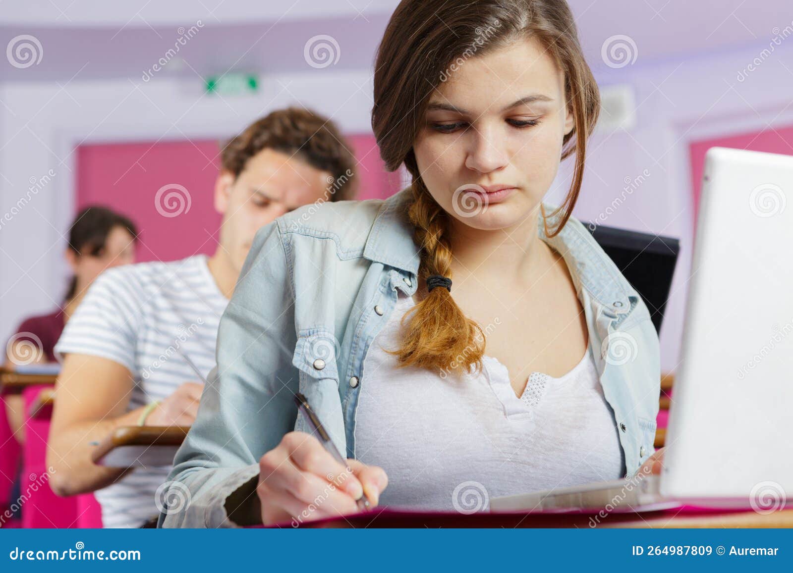 Female Student Writing Notes in Class Stock Image - Image of indoors ...