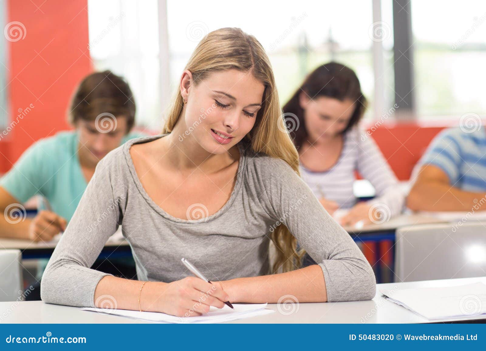 Female Student Writing Notes in Classroom Stock Photo - Image of ...