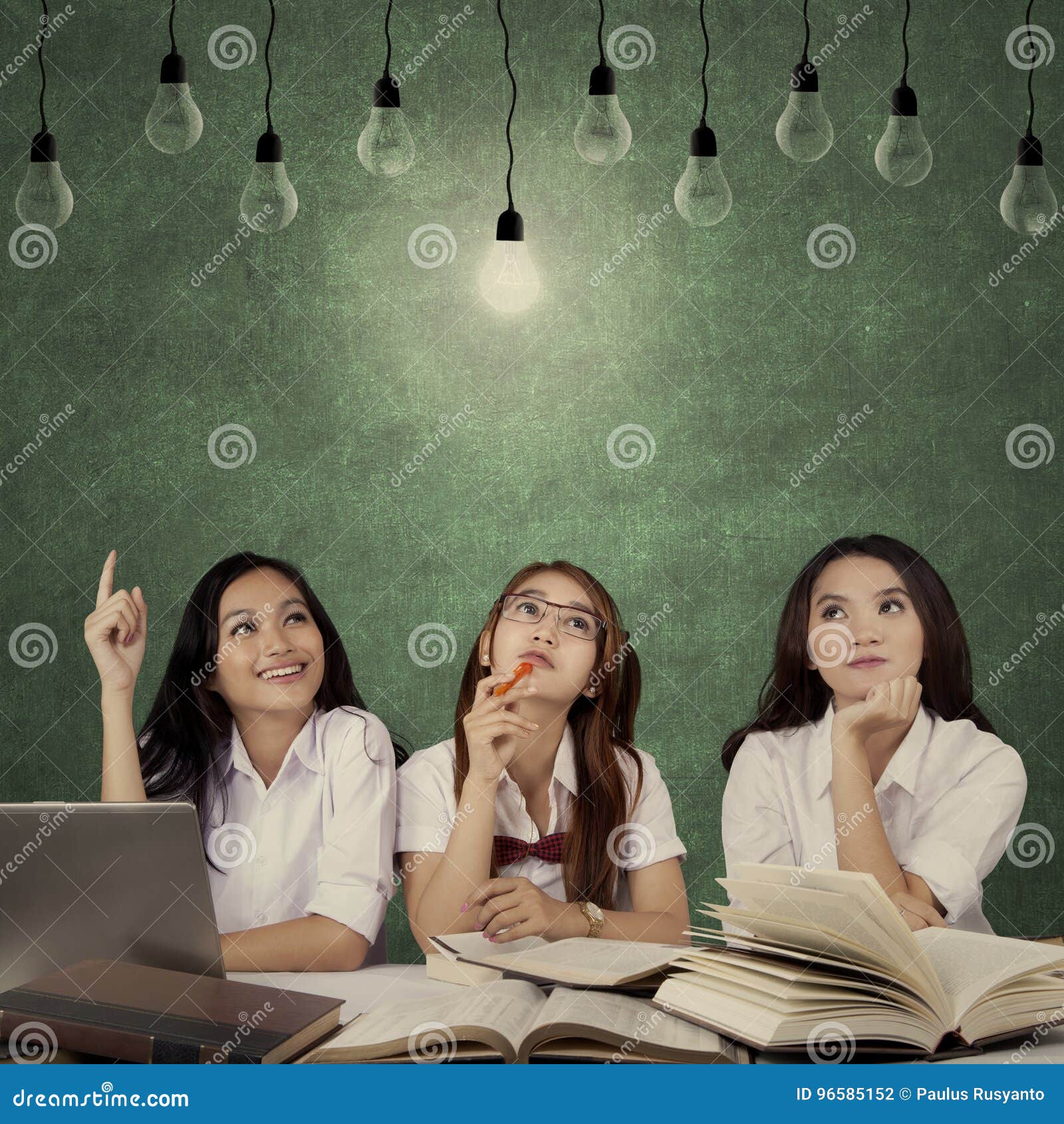 Female Students Sit Under Light Bulb Stock Photo - Image of classroom ...