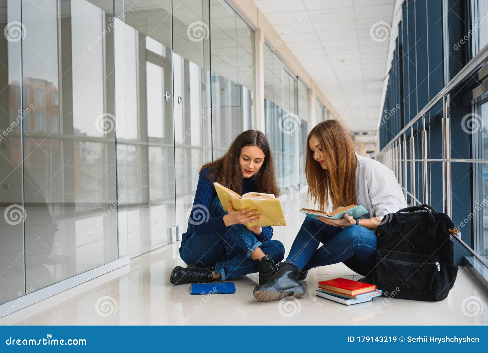 Female Students Sitting on the Floor and Reading Notes before Exam ...