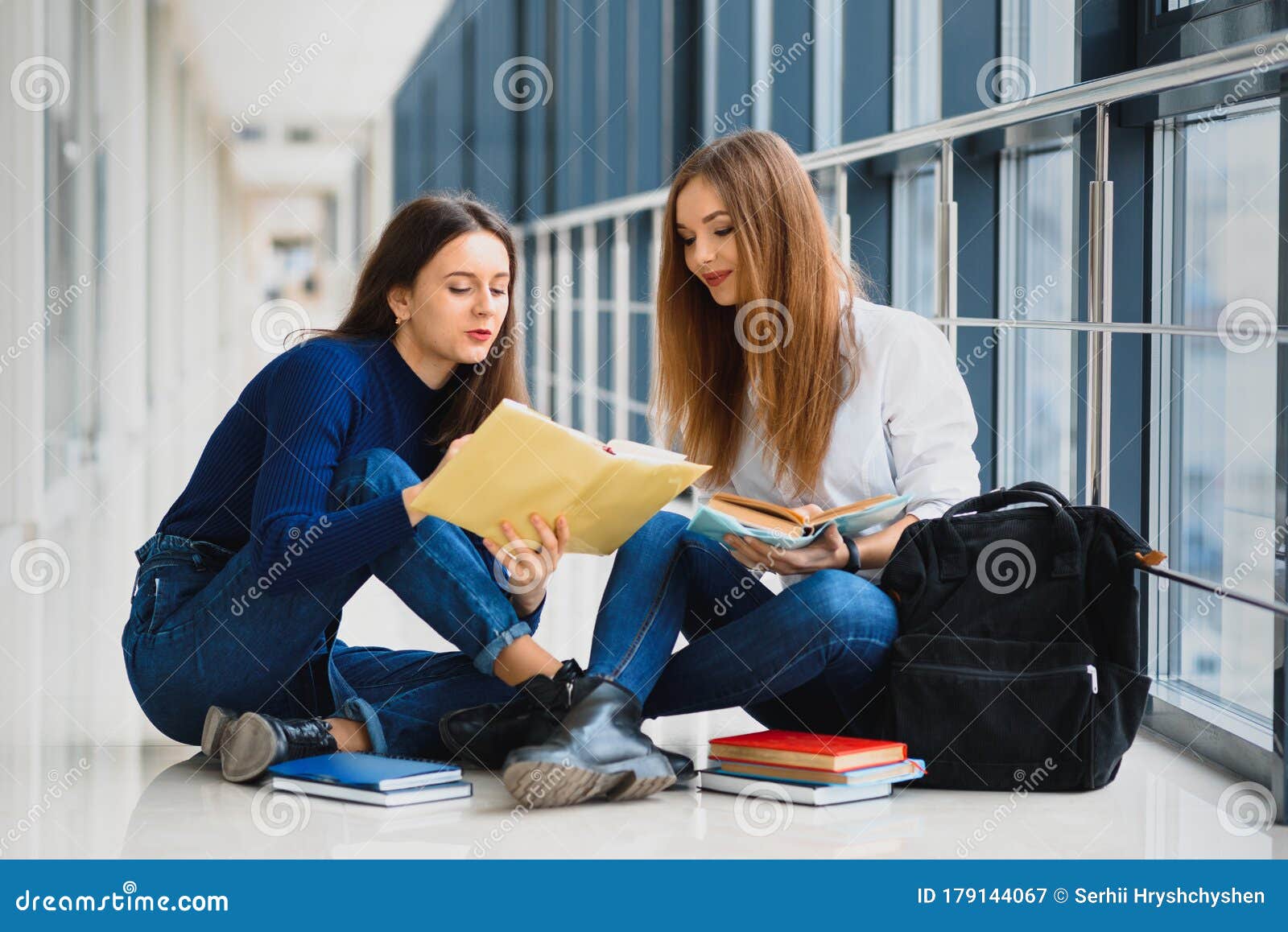 Female Students Sitting on the Floor and Reading Notes before Exam ...