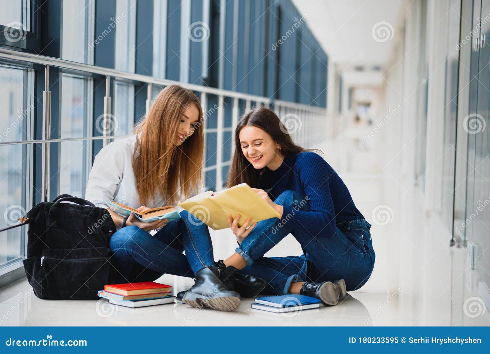 Female Students Sitting on the Floor and Reading Notes before Exam ...