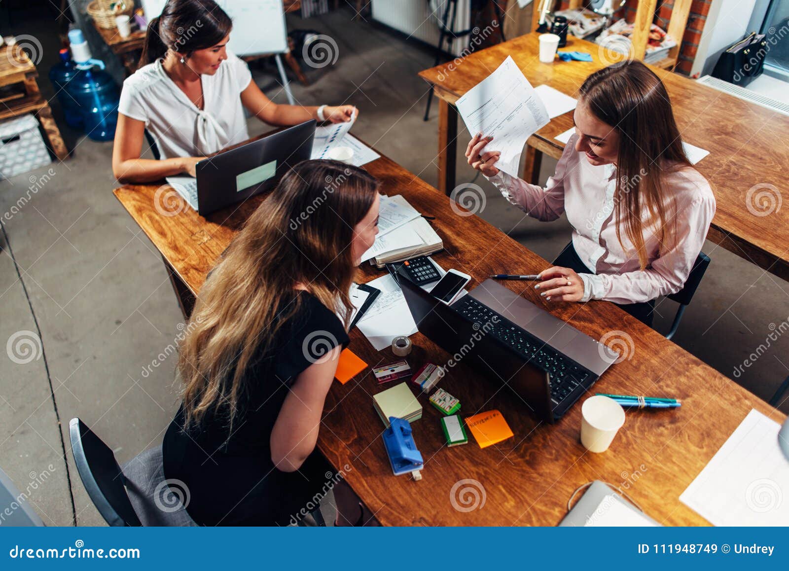 Female Students Working on School Assignment Using Laptops Sitting at ...