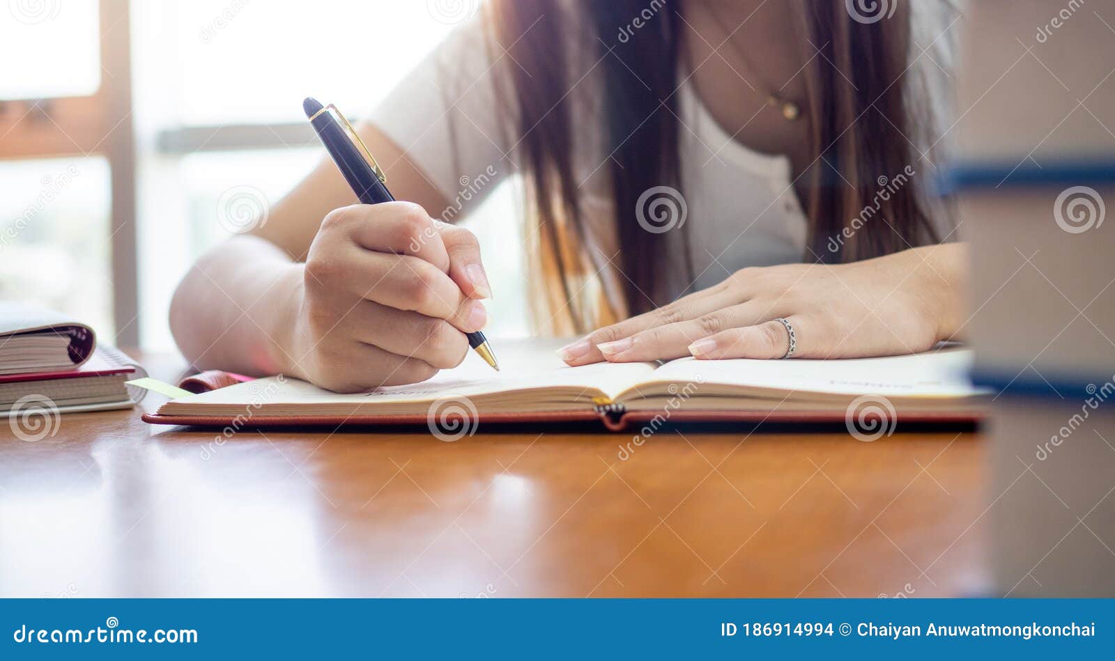 Female Students Writing and Reading in the Library Stock Photo - Image ...