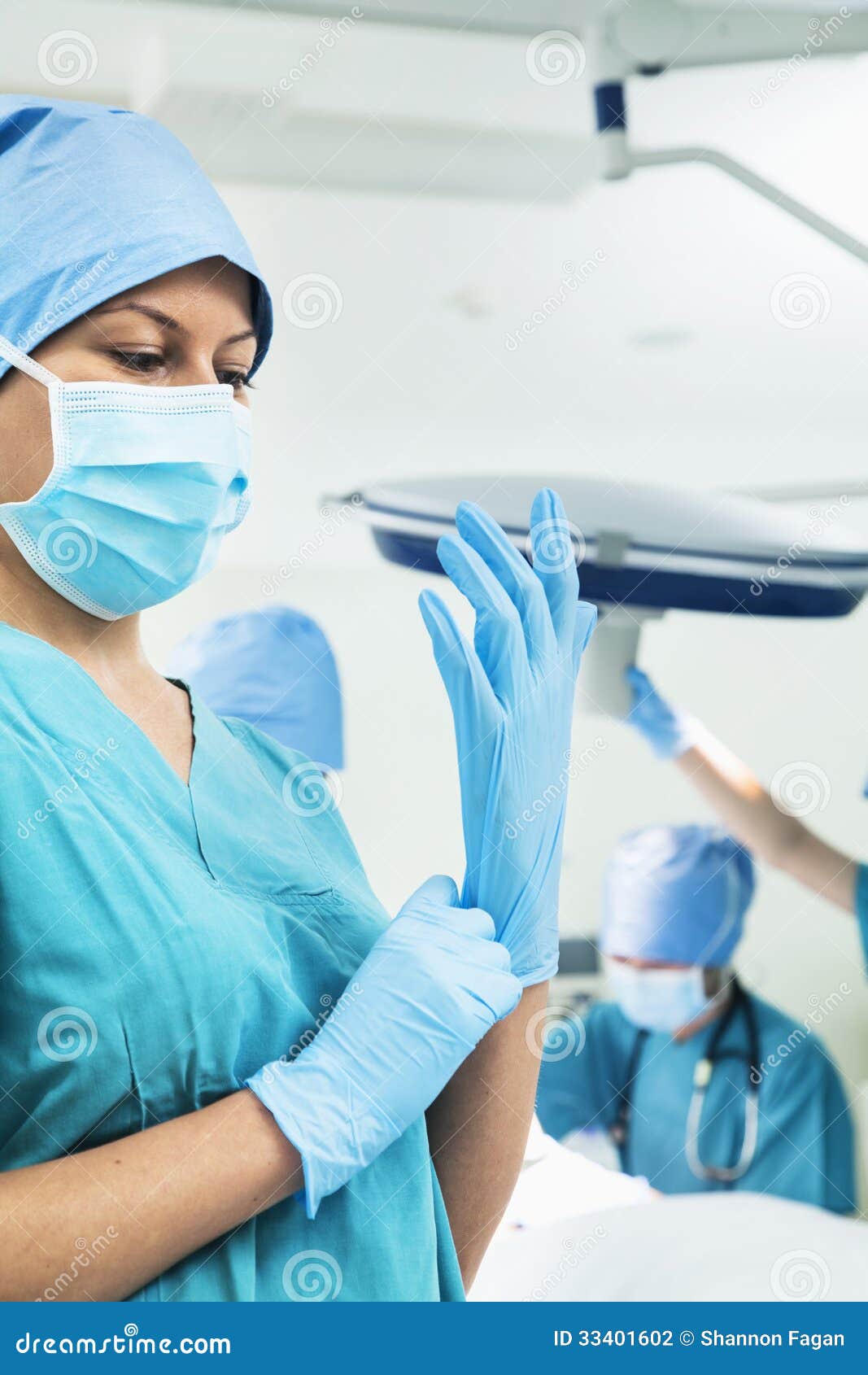 Female Surgeon Putting on Gloves in the Operating Room, Getting ...
