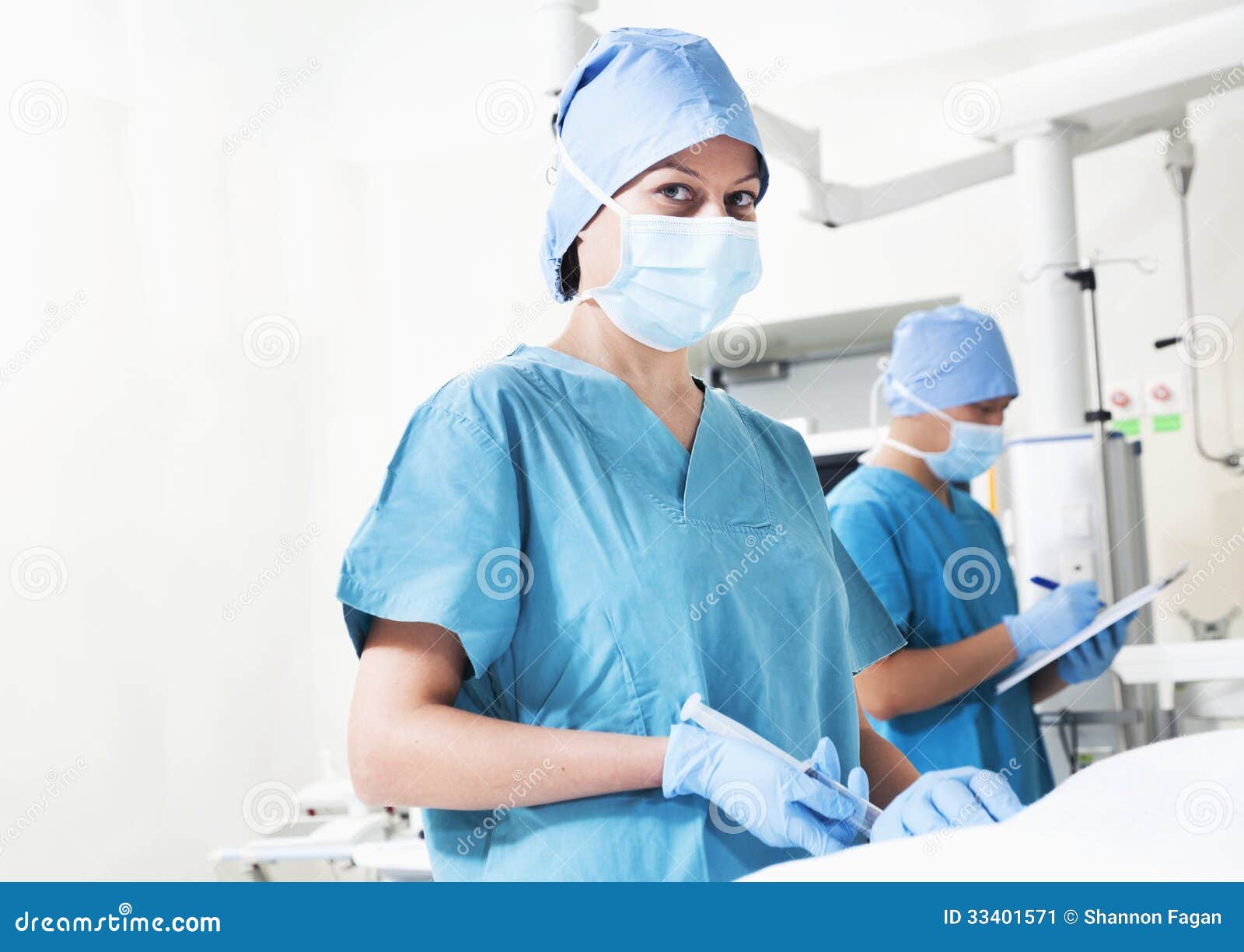 Female Surgeon Working in the Operating Room, Looking at Camera Stock ...