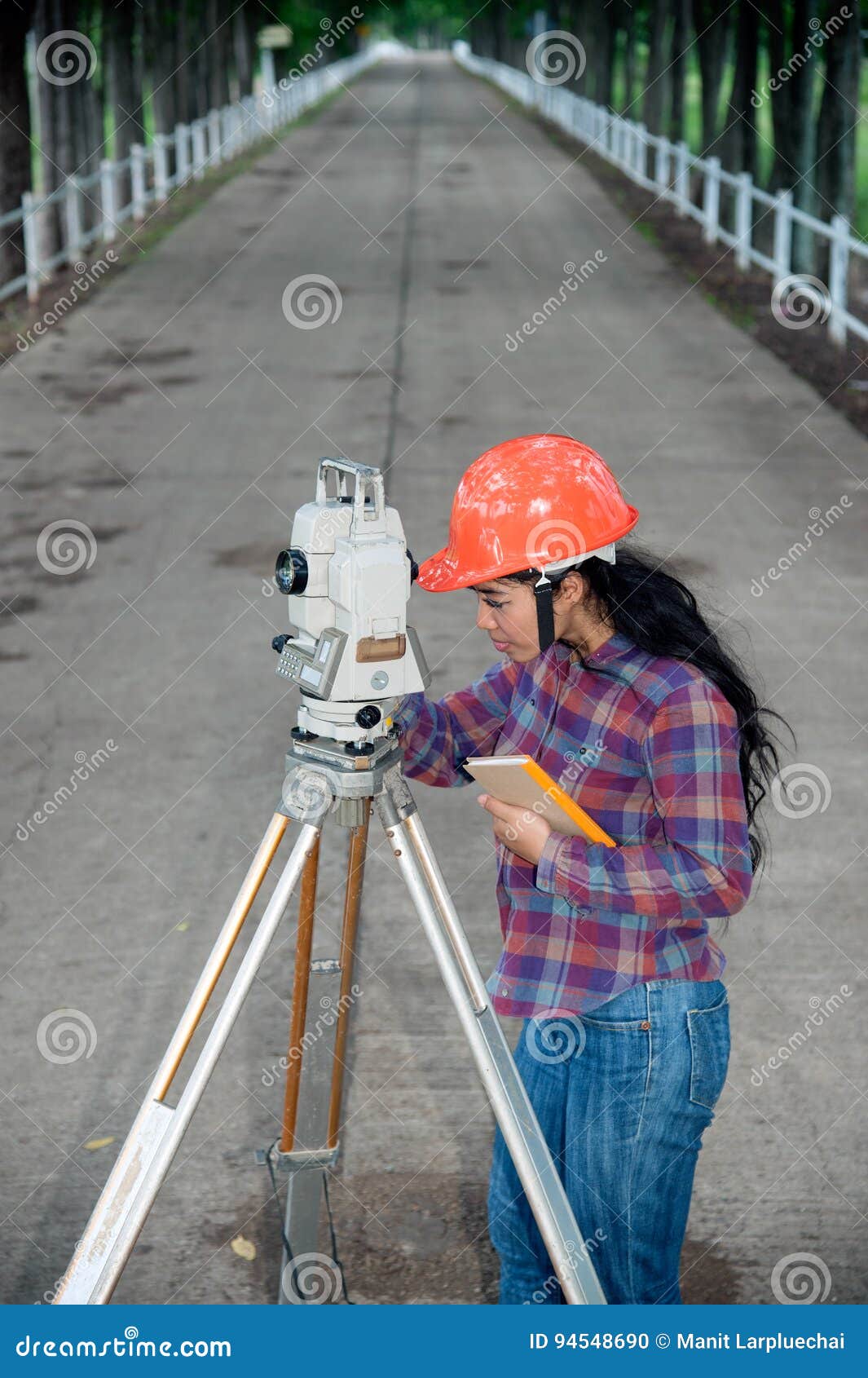 Female Surveyor or Engineer Making Measure on the Field. Stock Photo ...