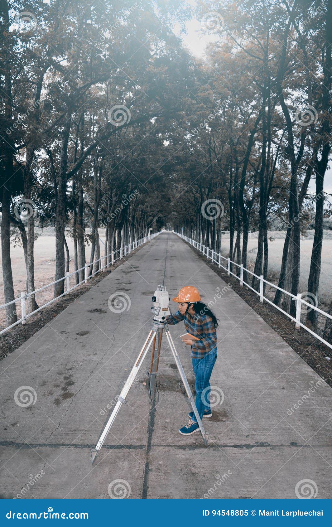 Female Surveyor or Engineer Making Measure on the Field. Stock Image ...