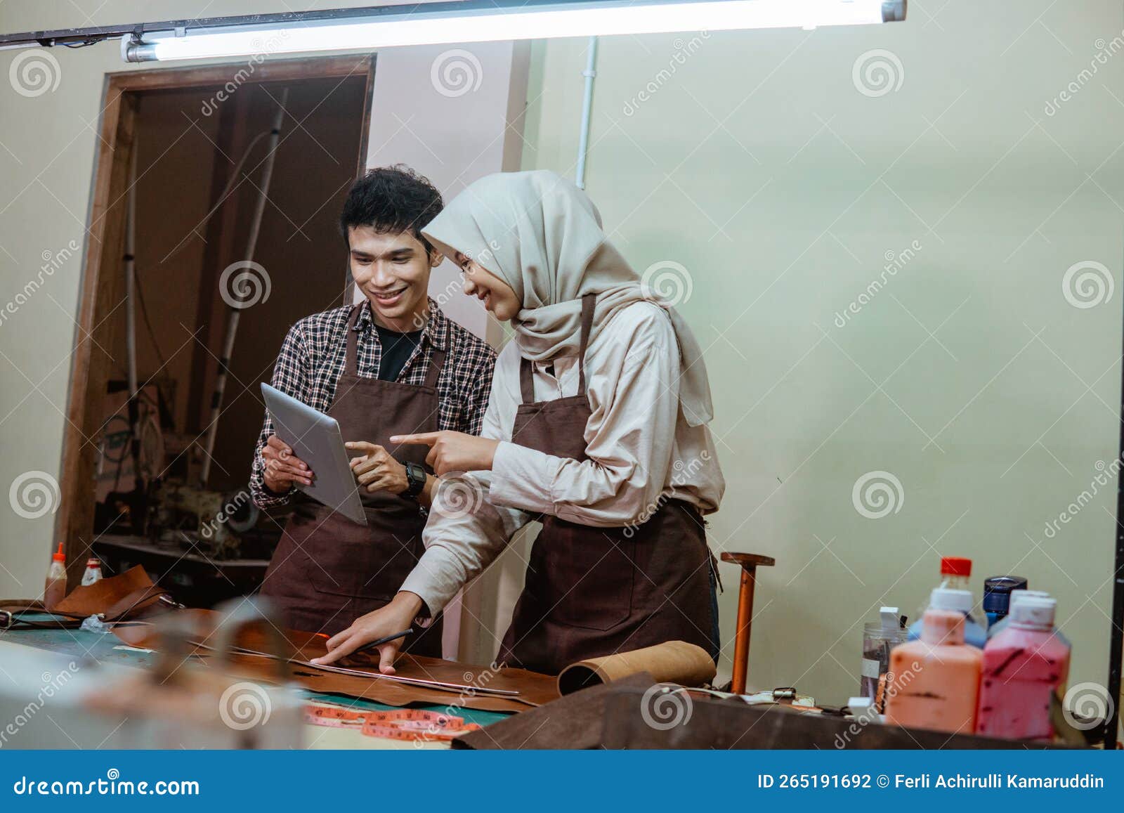 Female Tailor in Veil and Male Tailor Using Pad Stock Photo - Image of ...