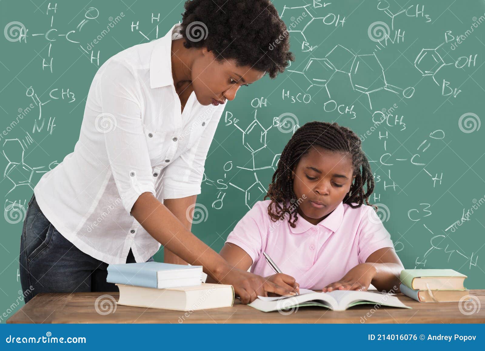 Female Teacher Assisting Student in Class Stock Photo - Image of help ...