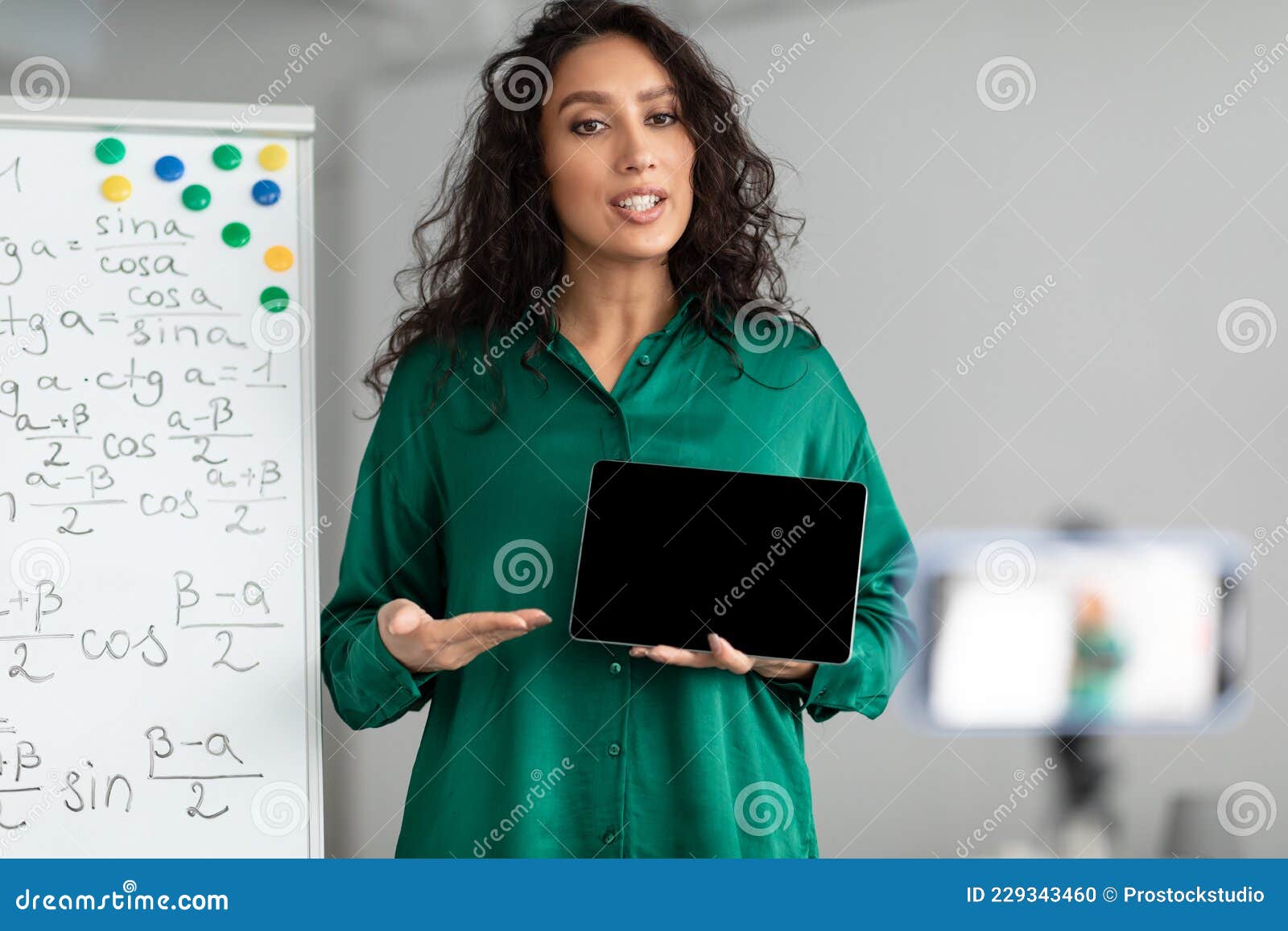 Female Teacher Explaining Math Online Showing Tablet To Students Stock ...