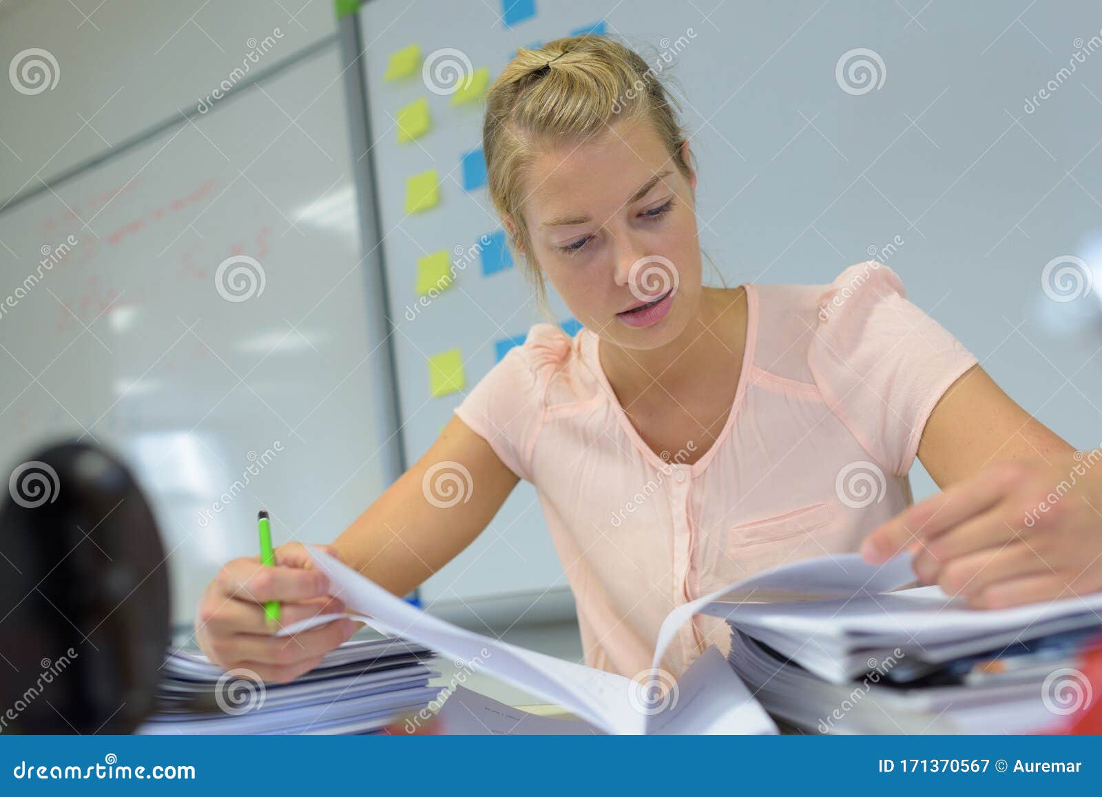 Female Teacher Flipping Notes at Desk Stock Image - Image of ...