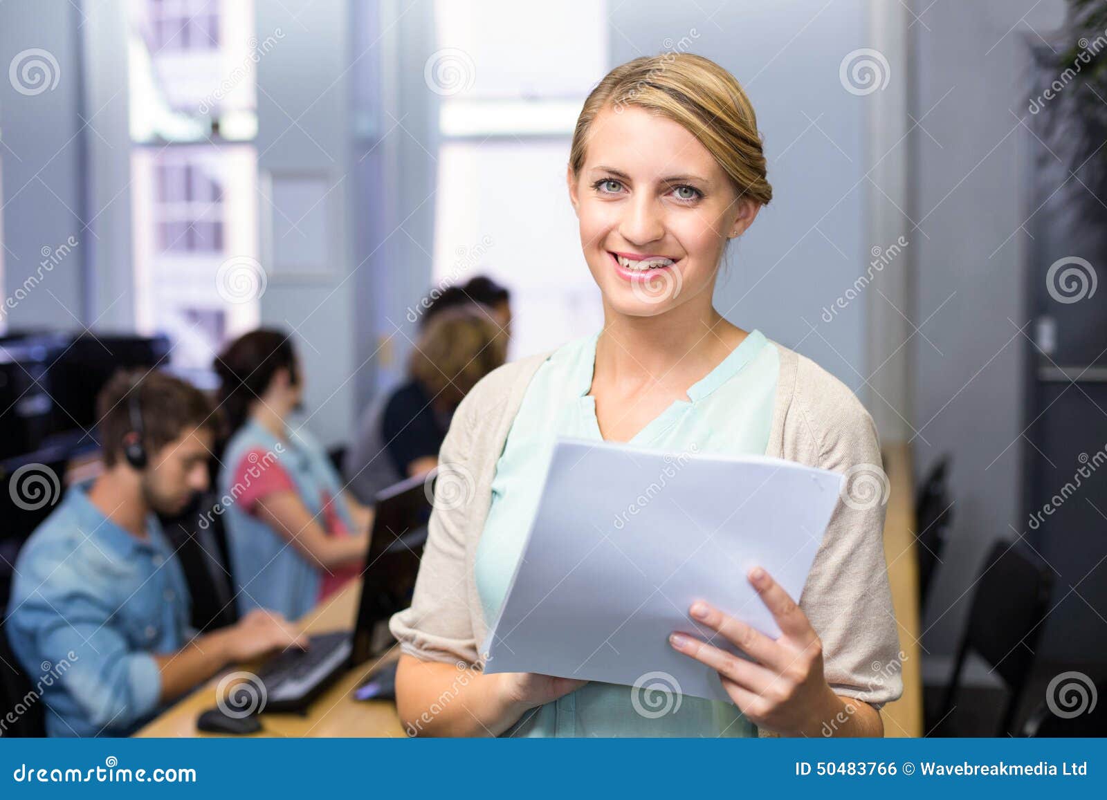Female Teacher Holding Document in Computer Class Stock Photo - Image ...