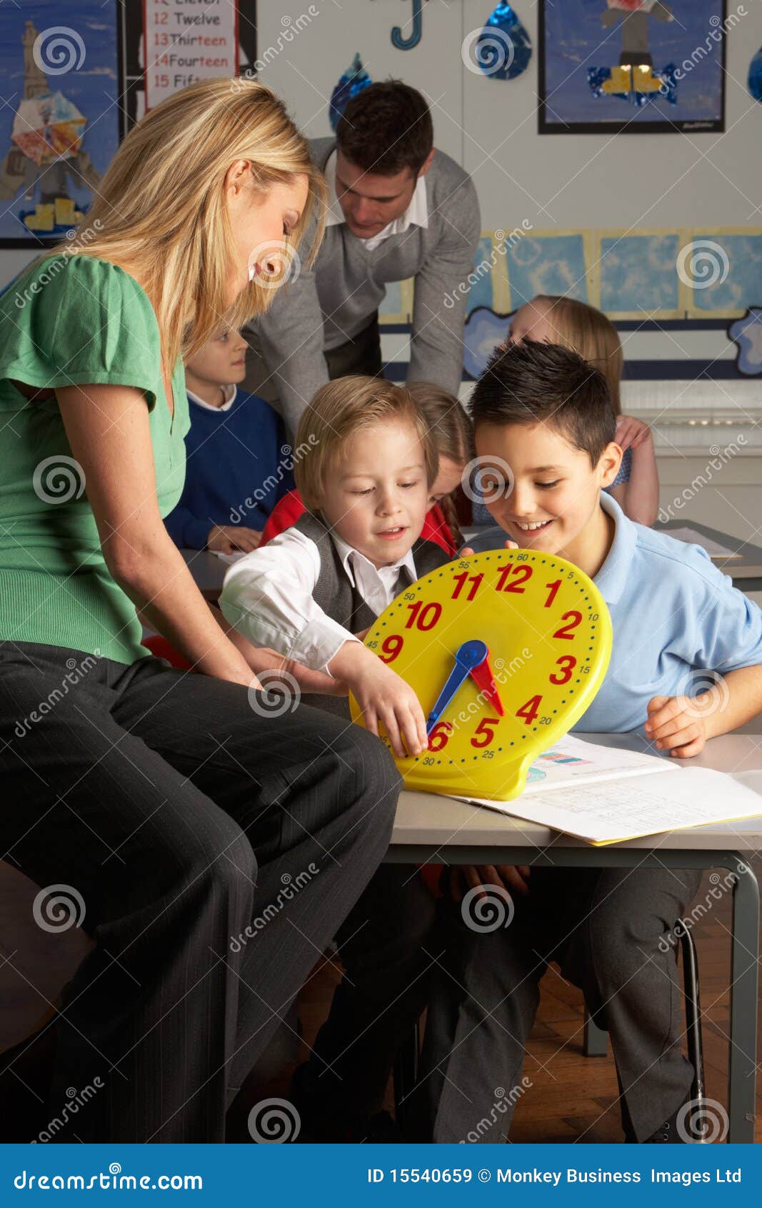 Female Teacher in Primary School Teaching Children Stock Image - Image ...
