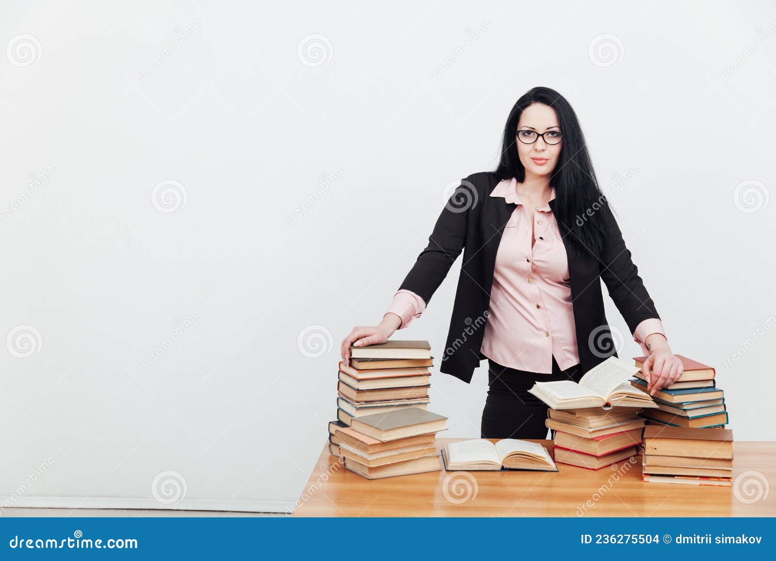 Female Teacher at a Table with Books for Teaching Stock Photo - Image ...