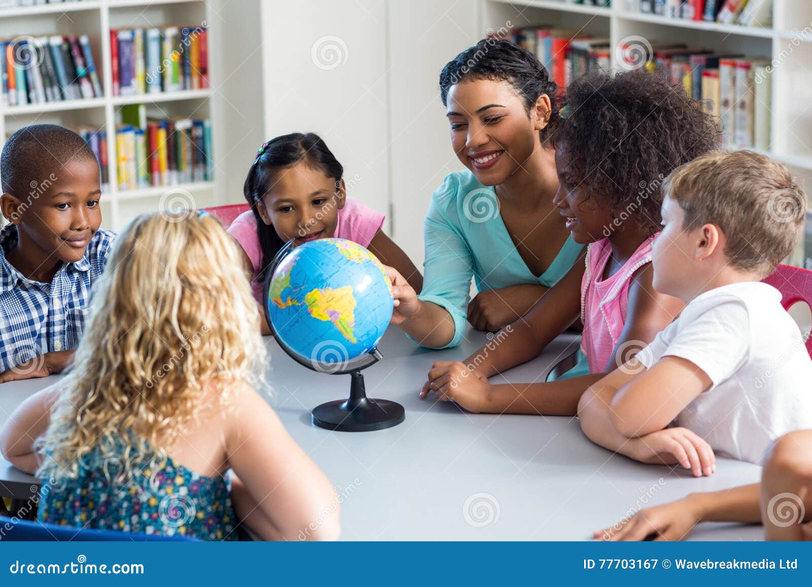Female Teacher Teaching Children Using Globe Stock Image - Image of ...