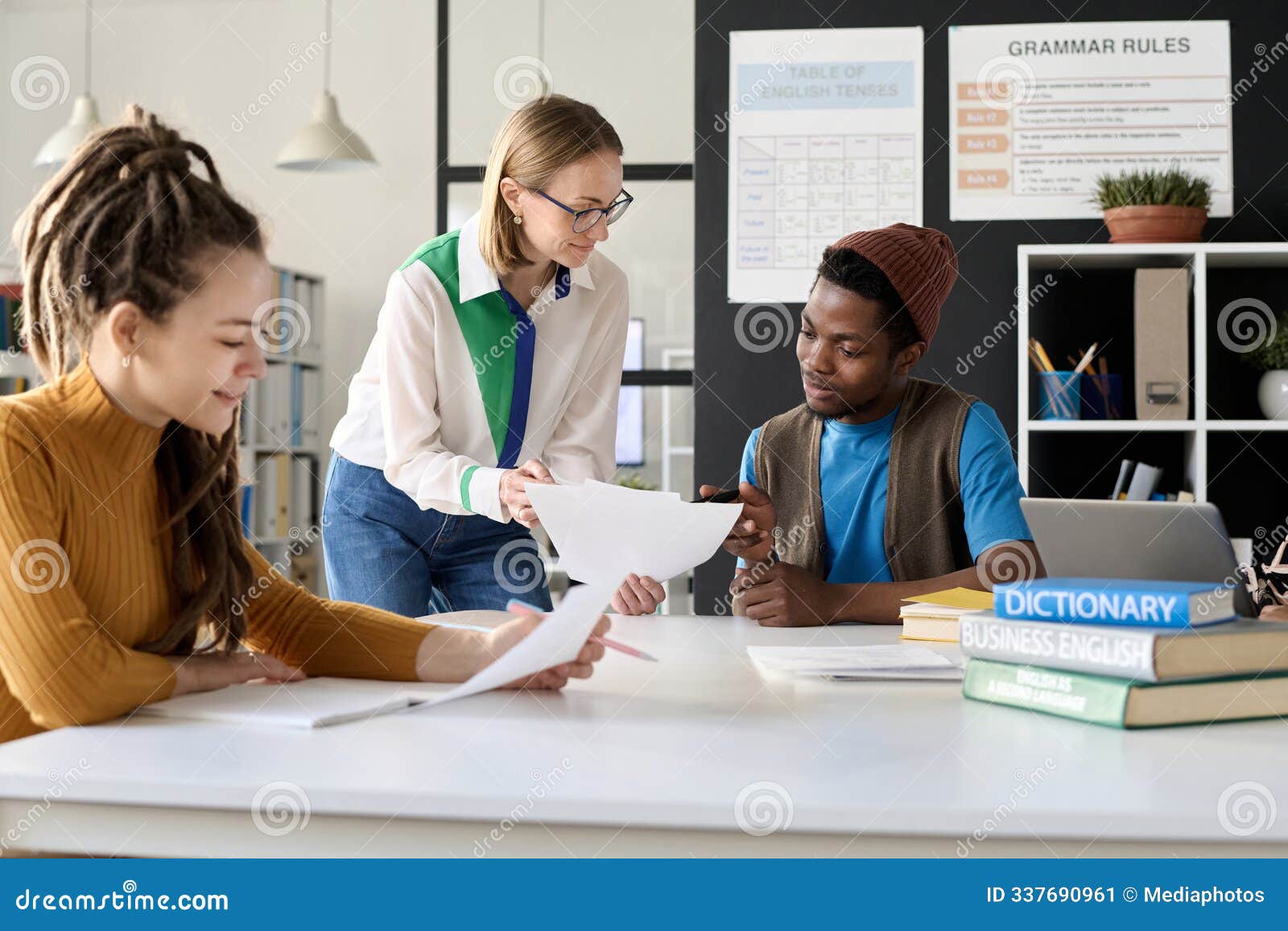 Female Teacher Teaching Students during Class in School or College ...