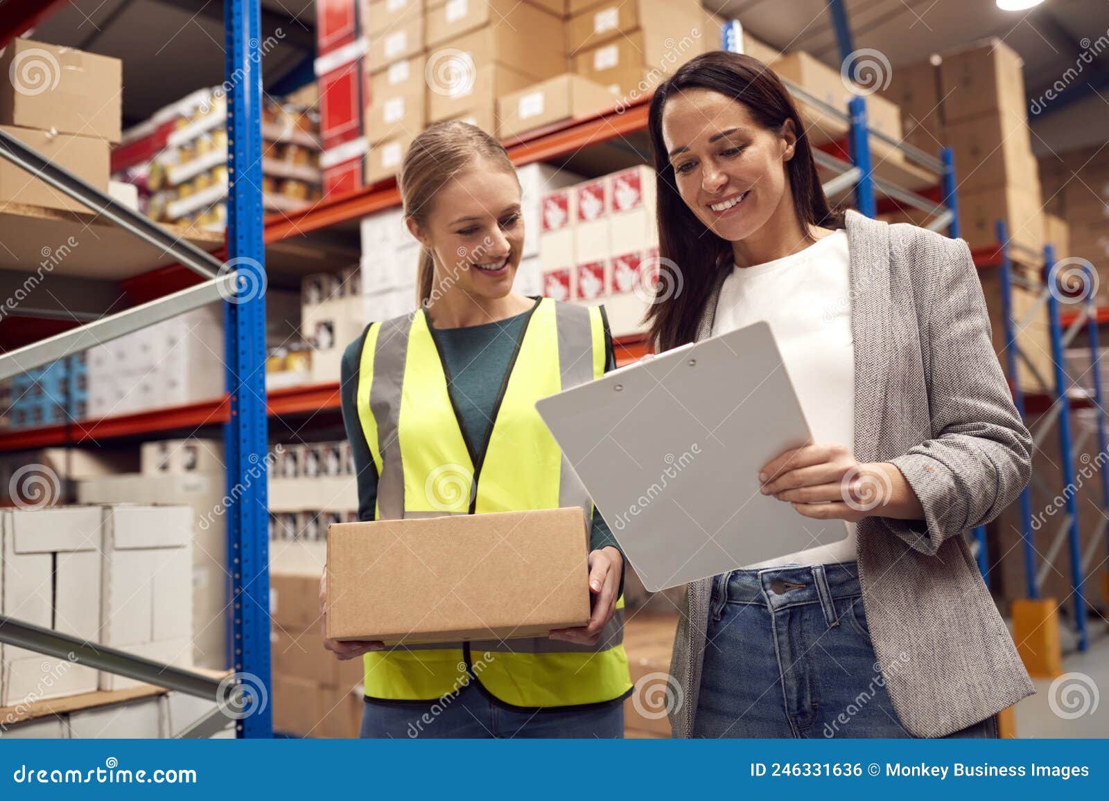 Female Team Leader with Clipboard in Warehouse Training Intern Standing ...