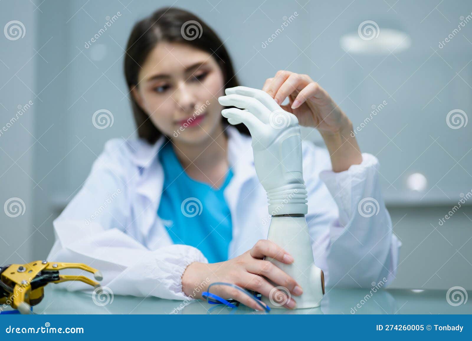 Female Technician Checking and Controlling Artificial Prosthetic Hand ...