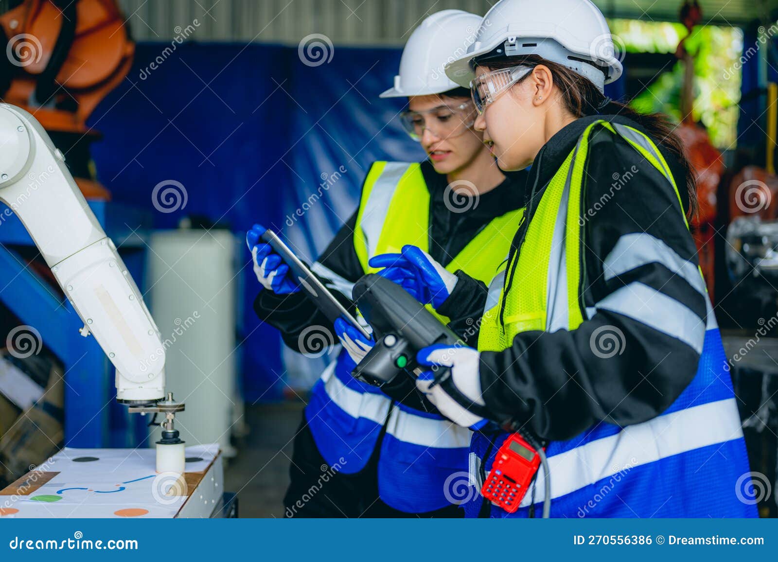 Female Technician Engineer Using Controller Checking Robotic Machine ...