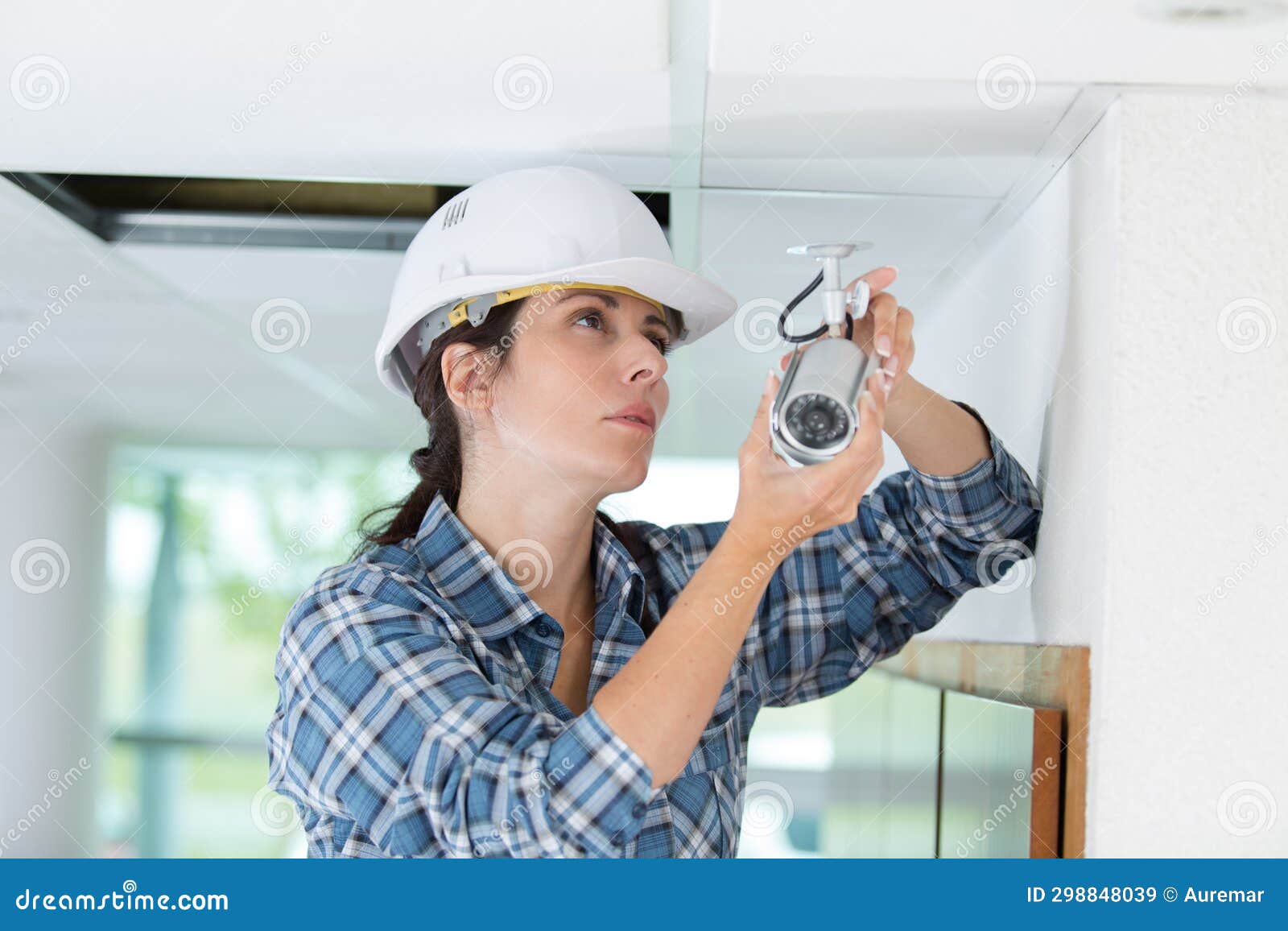 Female Technician Installing Camera on Wall with Screwdriver Stock ...