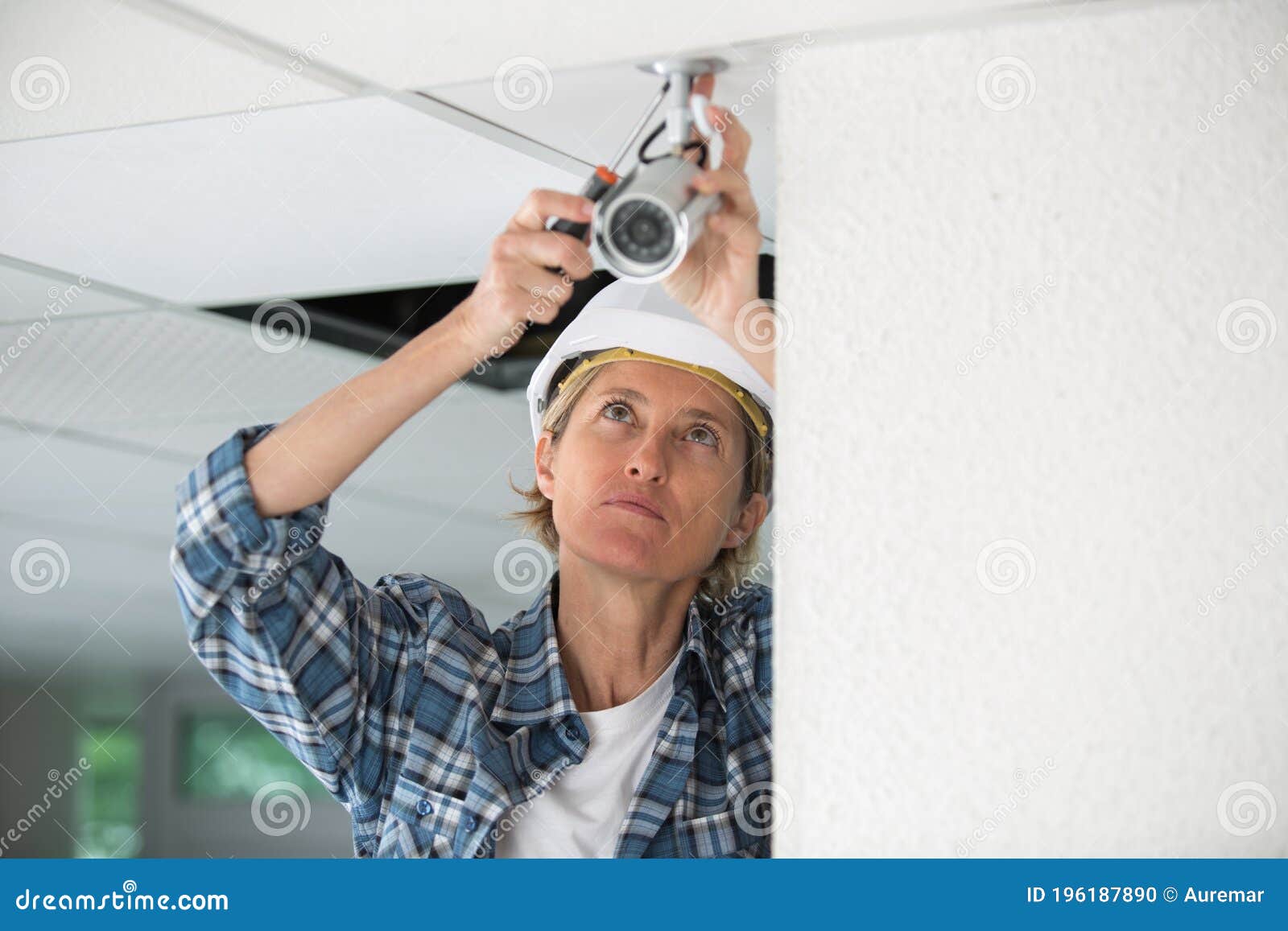 Female Technician Installing Cctv with Screwdriver Stock Photo - Image ...