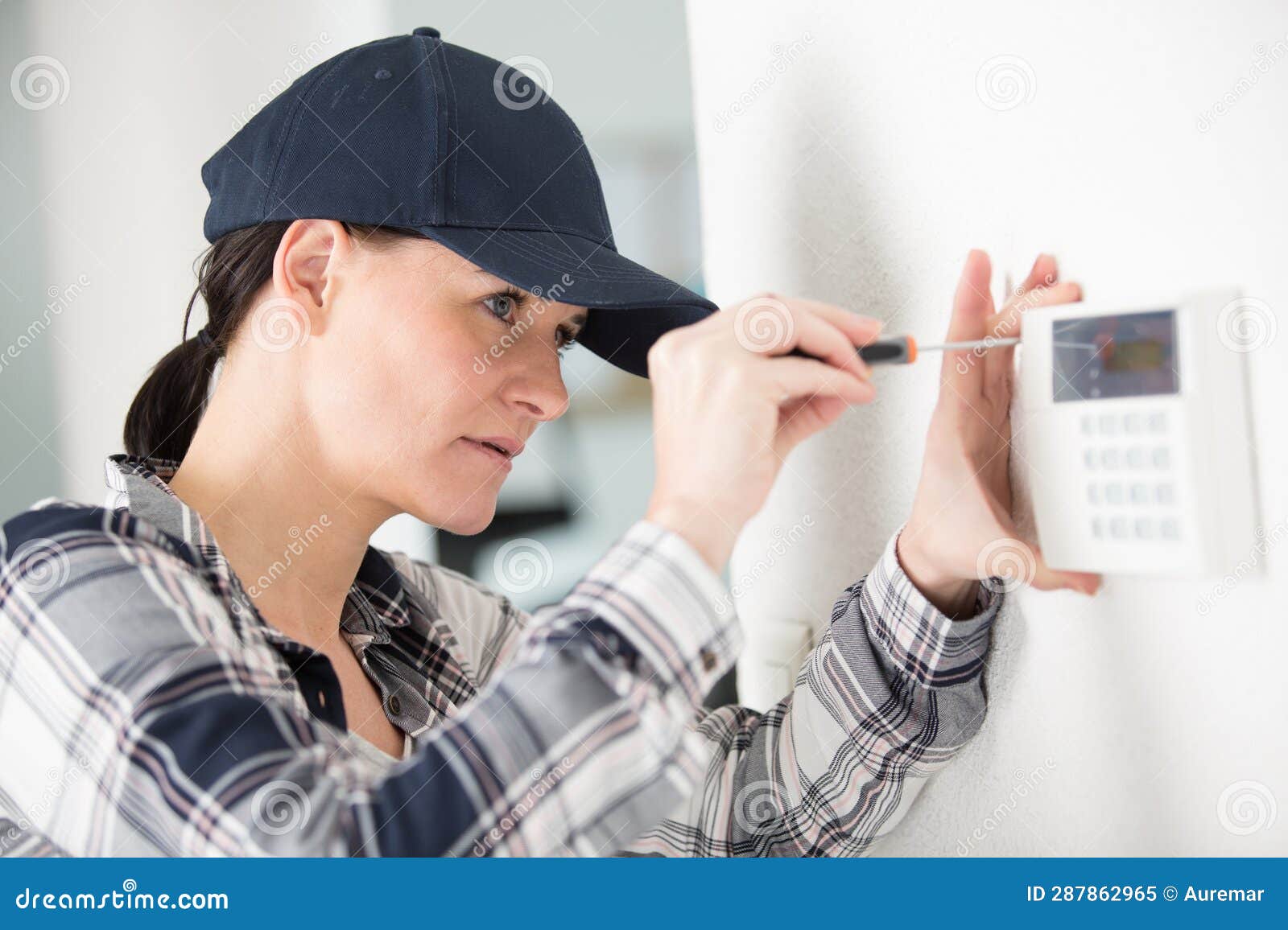 Female Technician Installing Security System Using Screwdriver Stock ... Female Technician Installing Security System Using Screwdriver Stock ...