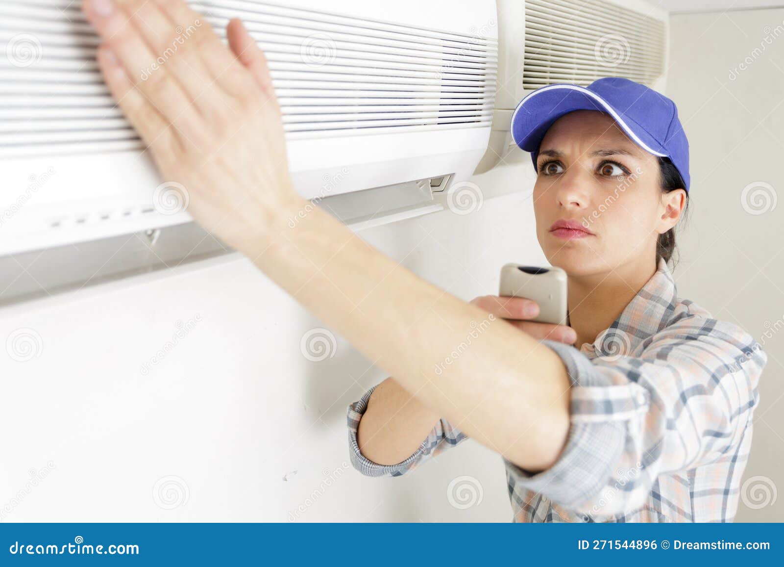 Female Technician Operating Air Conditioning Controls Stock Photo ...
