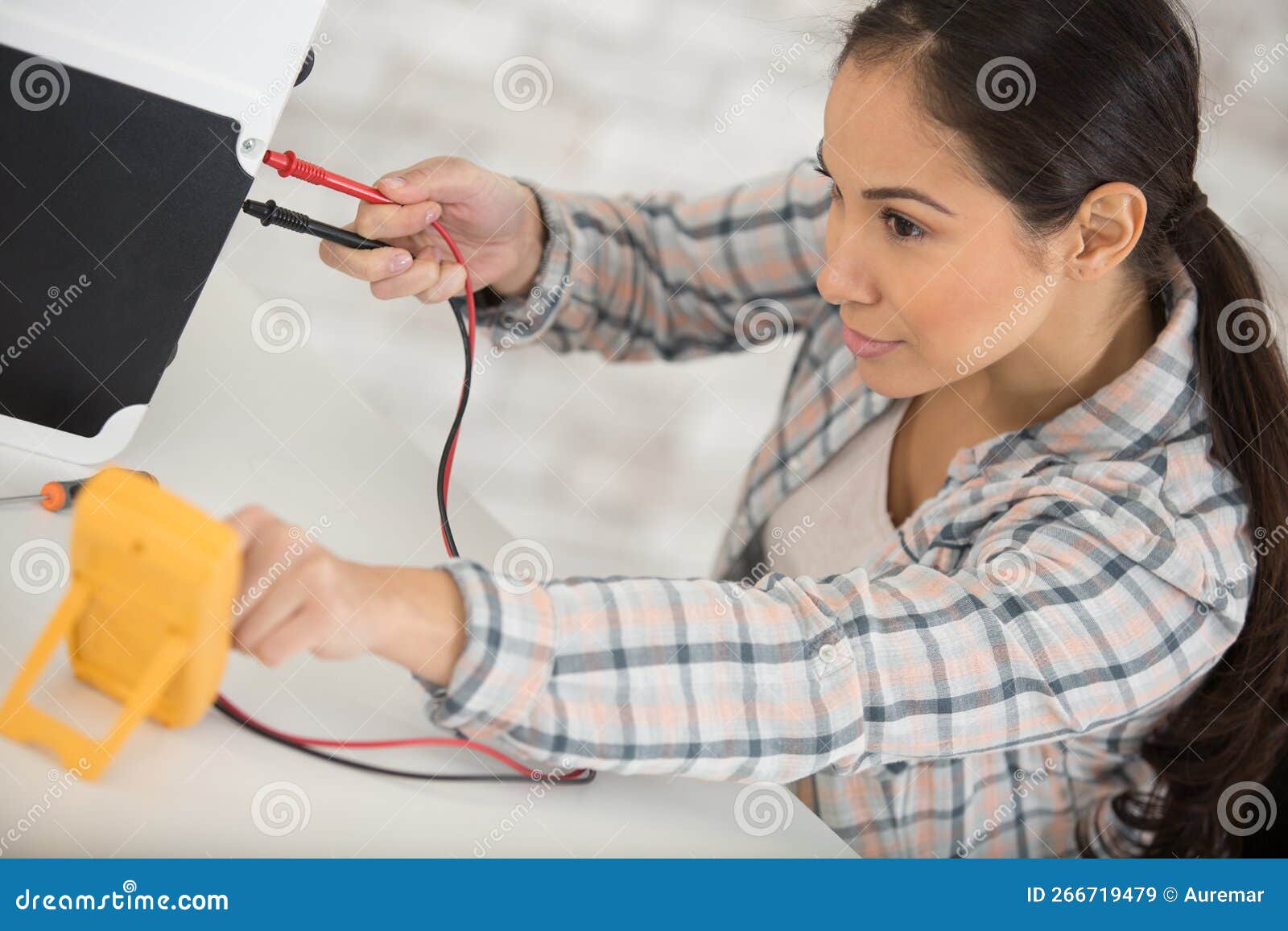 Female Technician Testing Appliance with Multimeter Stock Image - Image ...
