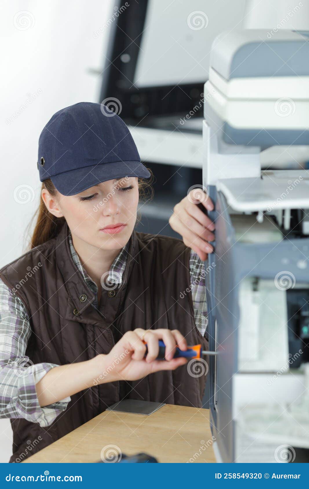 Female Technician Using Screwdriver on Photocopier Stock Photo - Image ...