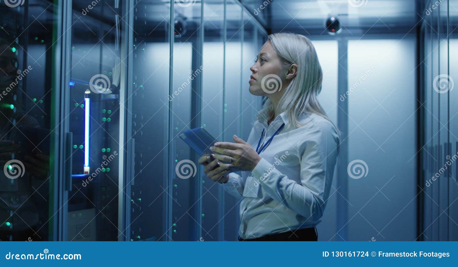 Female Technician Works on a Tablet in a Data Center Stock Photo ...