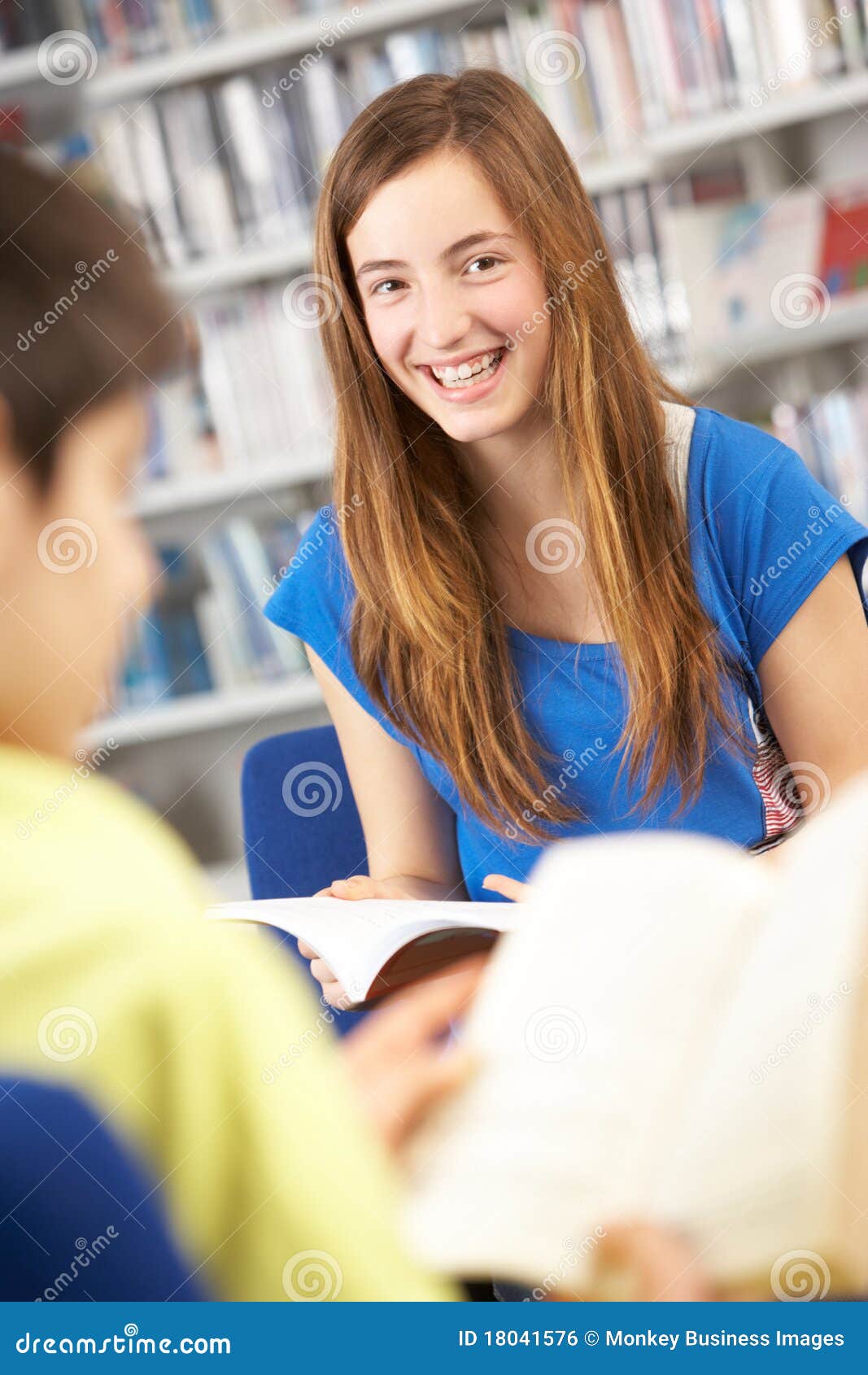 Female Teenage Student in Library Reading Book Stock Photo - Image of ...