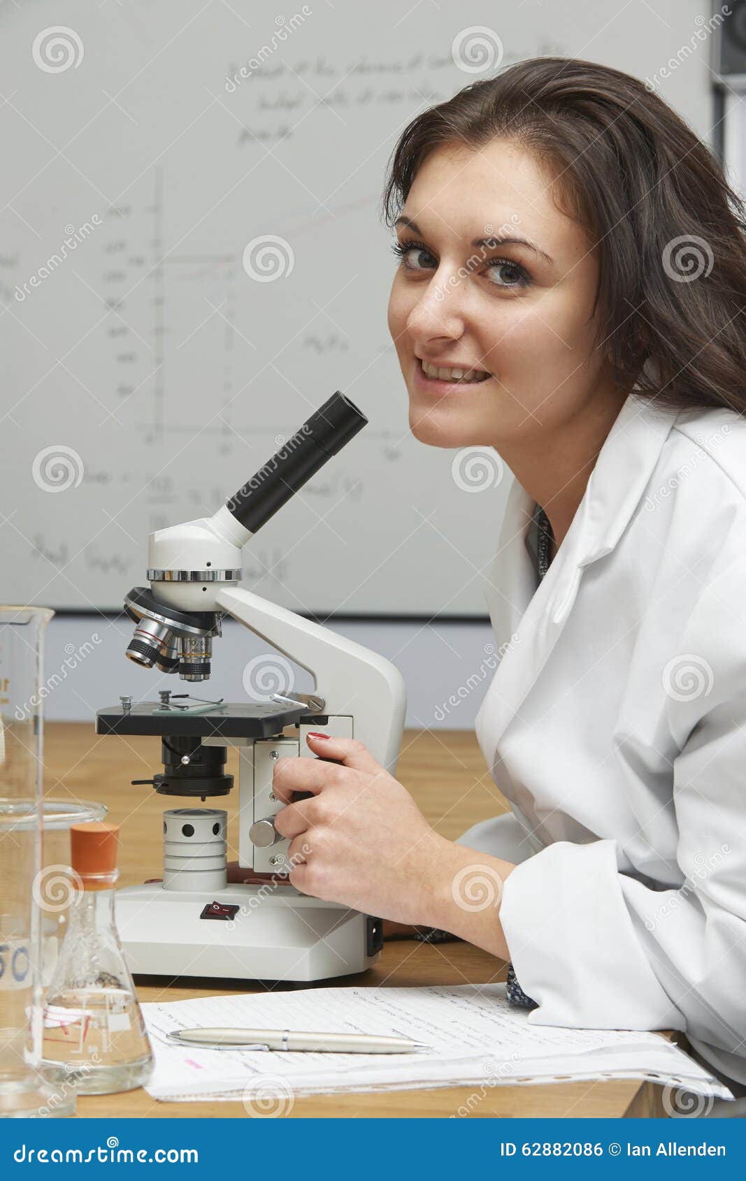 Female Teenage Student Using Microscope in Science Class Stock Photo ...