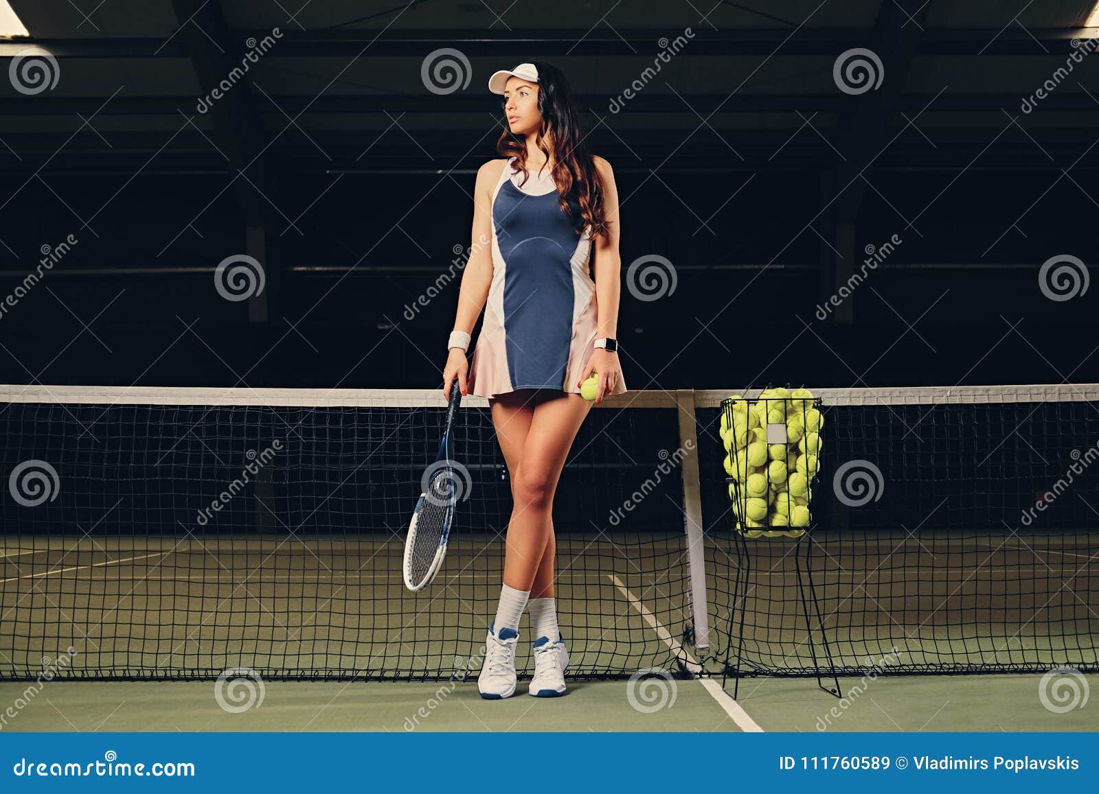 Female Tennis Player Posing On An Indoor Tennis Court Stock Image