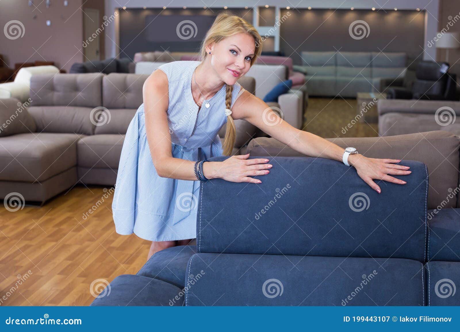 Female is testing new sofa stock image. Image of girl - 199443107
