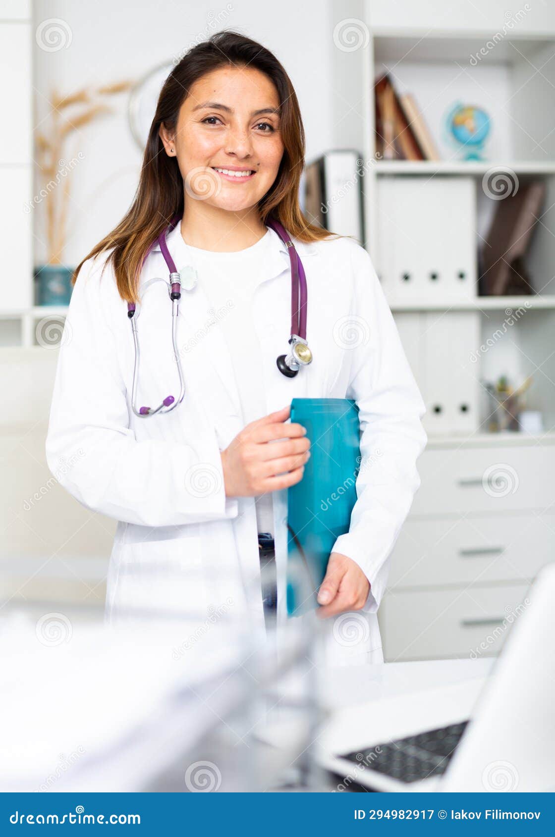 Female Therapist Stands with a Folder of Documents in the Office Stock ...