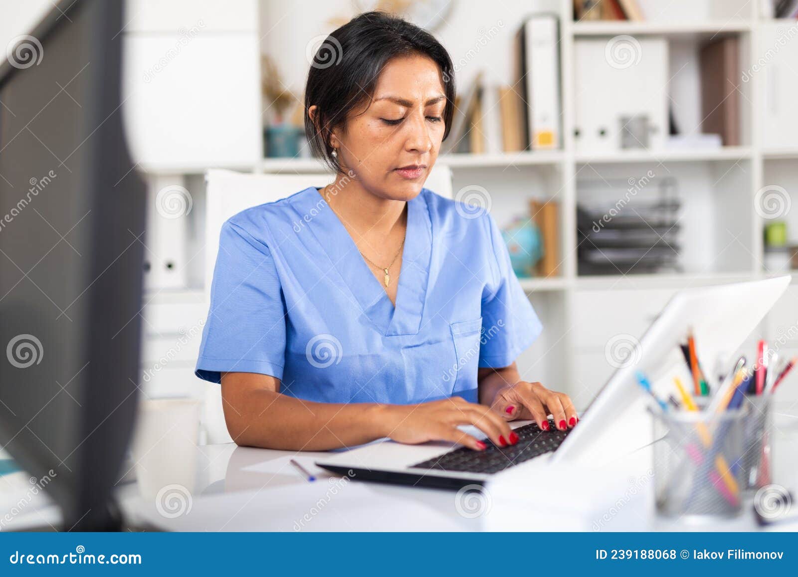 Female Therapist Working with Case Histories on Laptop Stock Photo ...