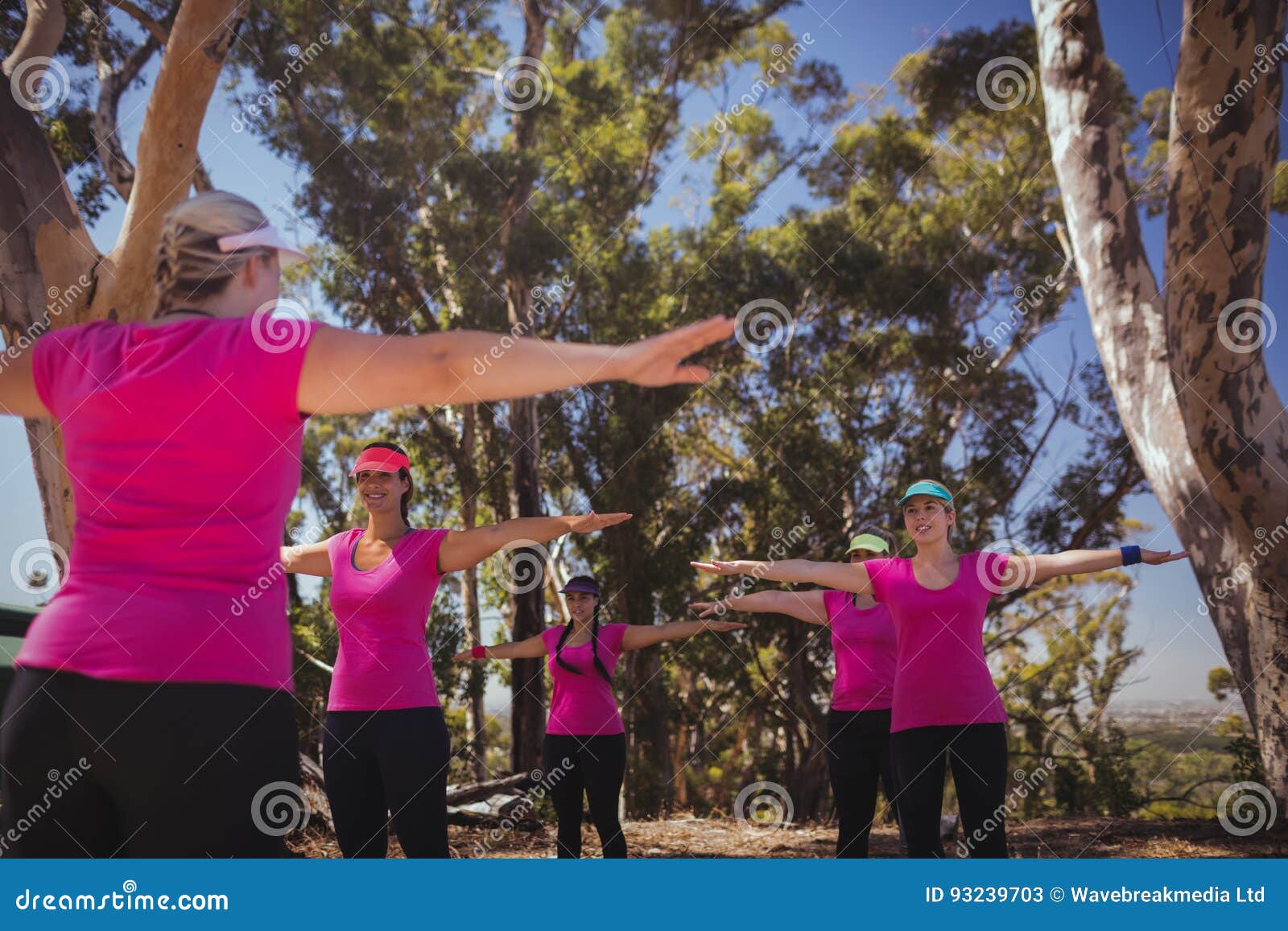 Female Trainer Instructing Women while Exercising in the Boot Camp ...