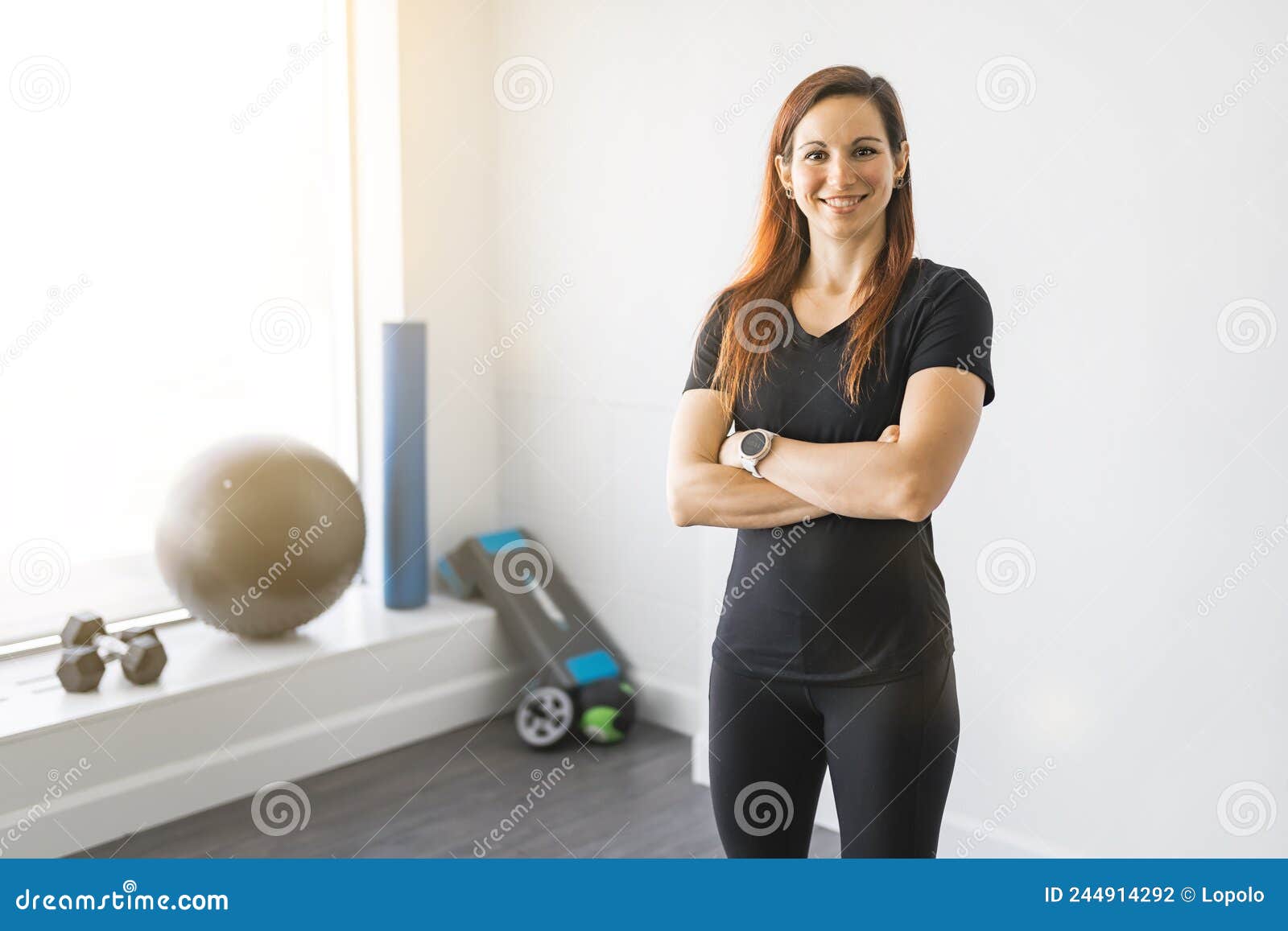 Female Trainer Standing with a Smile in the Training Gym Stock Photo ...
