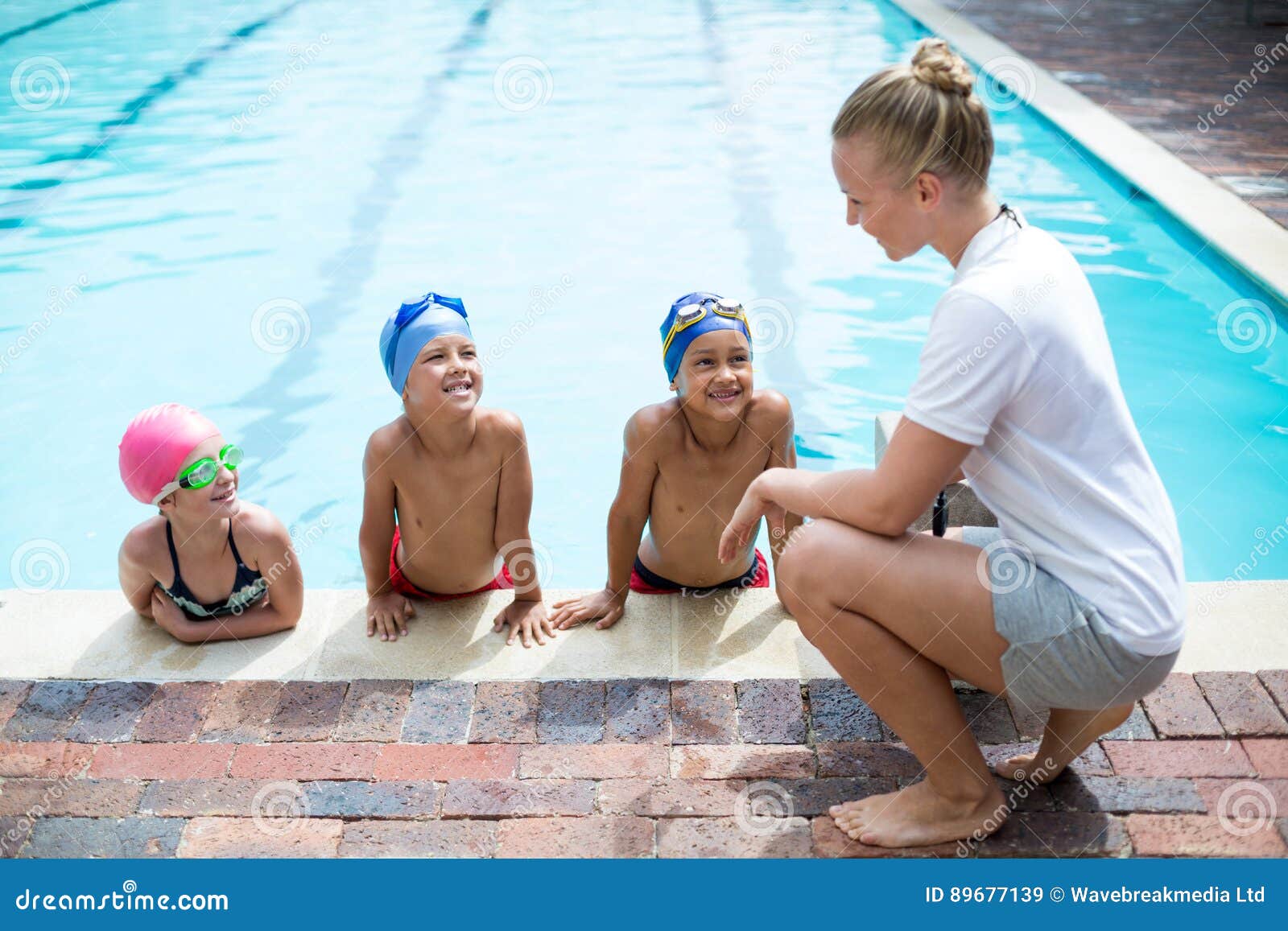 Female Trainer Teaching Students at Pool Side Stock Image - Image of ...