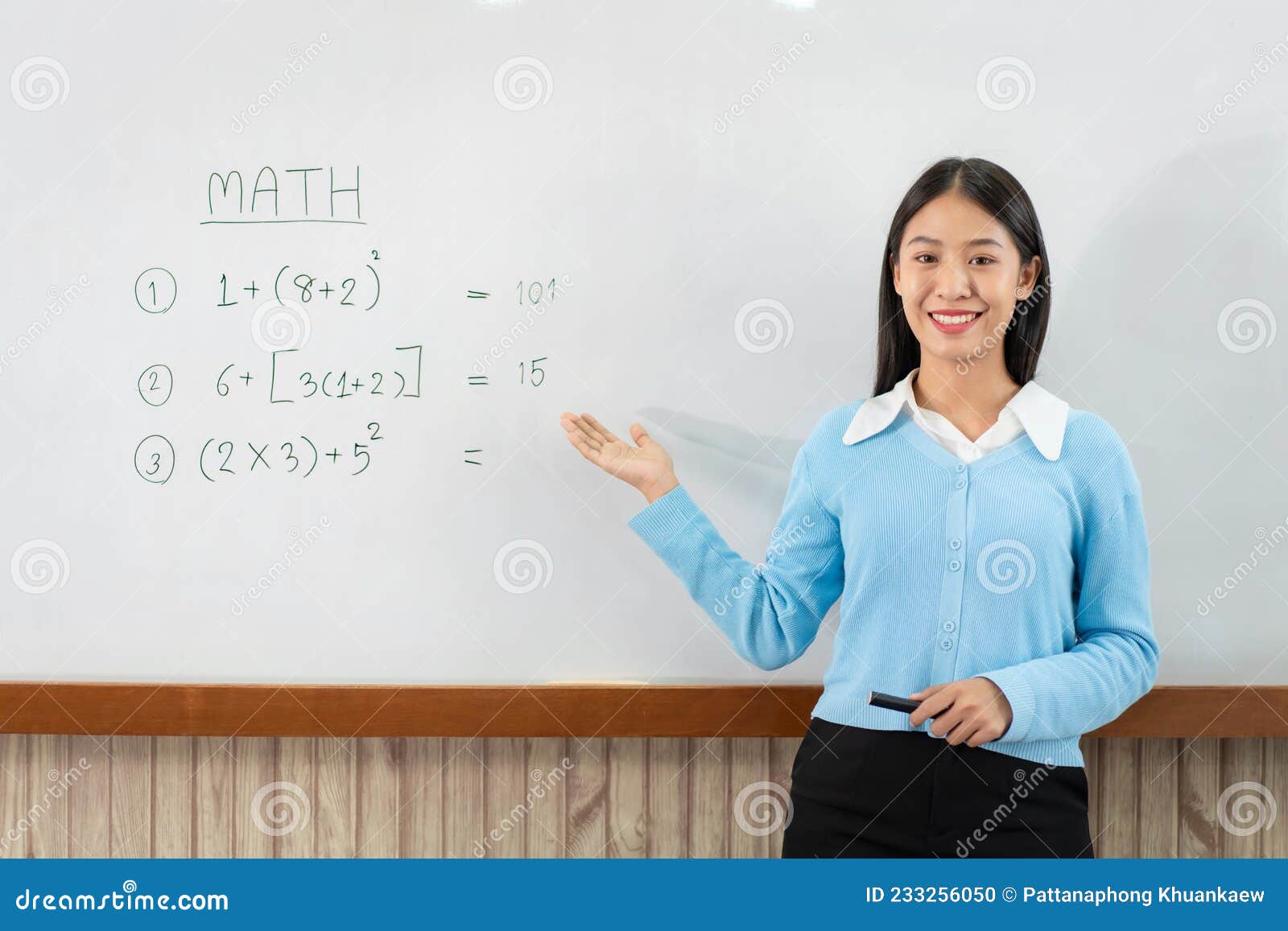 Female Tutor Standing in Front of Whiteboard and Writing Math Equations ...