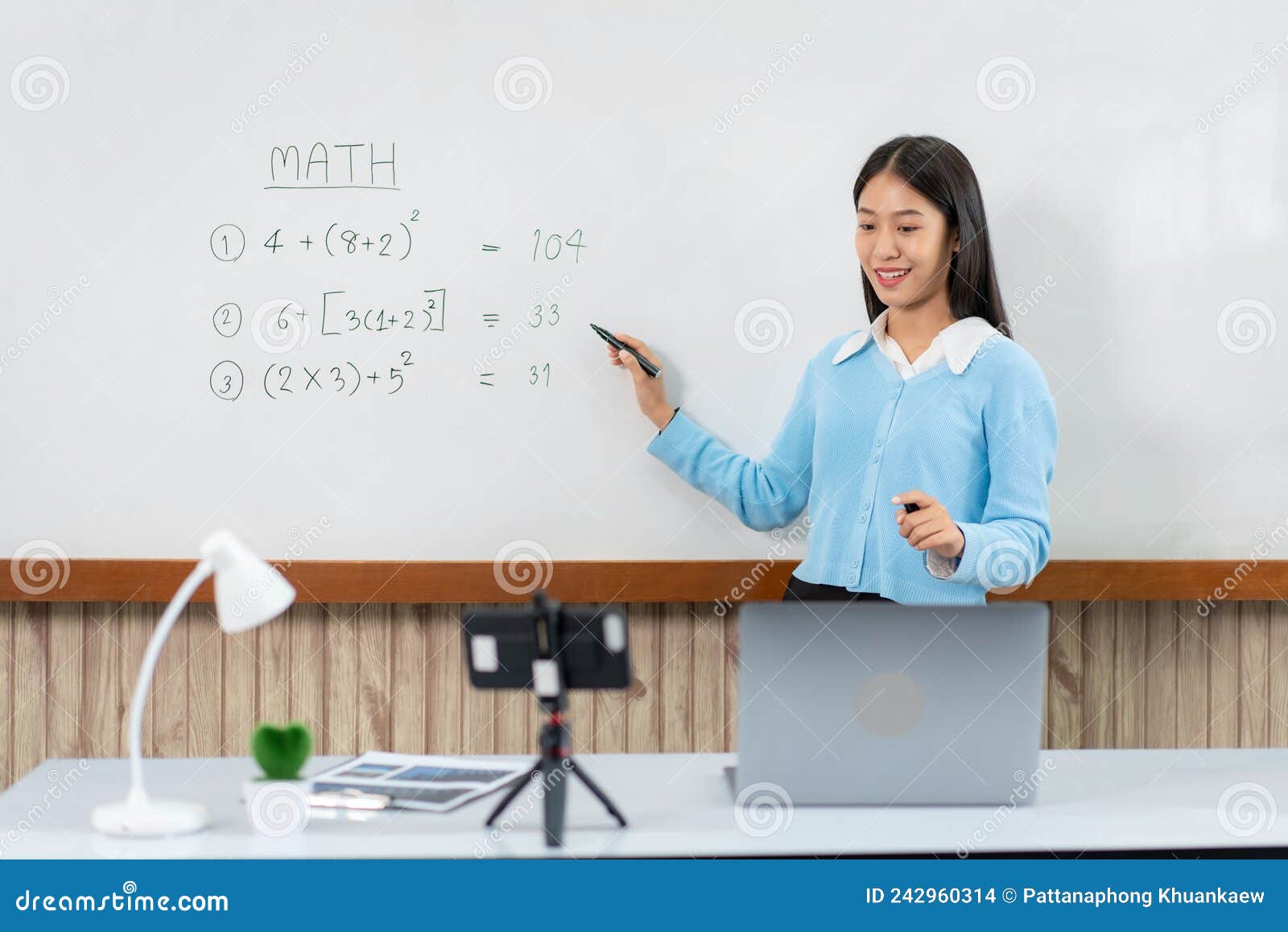 Female Tutor Standing in Front of Whiteboard and Writing Math Equations ...