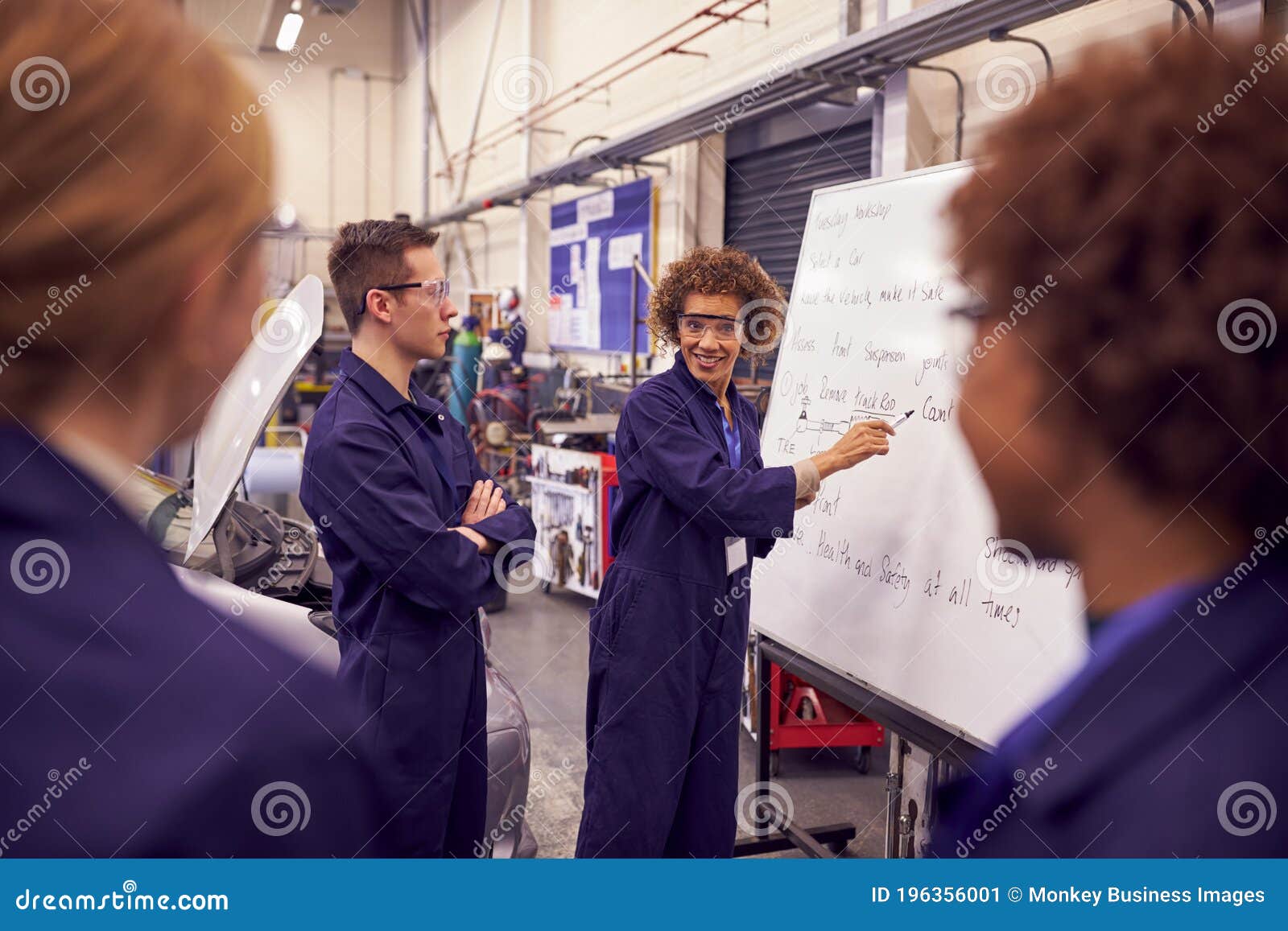 Female Tutor by Whiteboard with Students Teaching Auto Mechanic ...