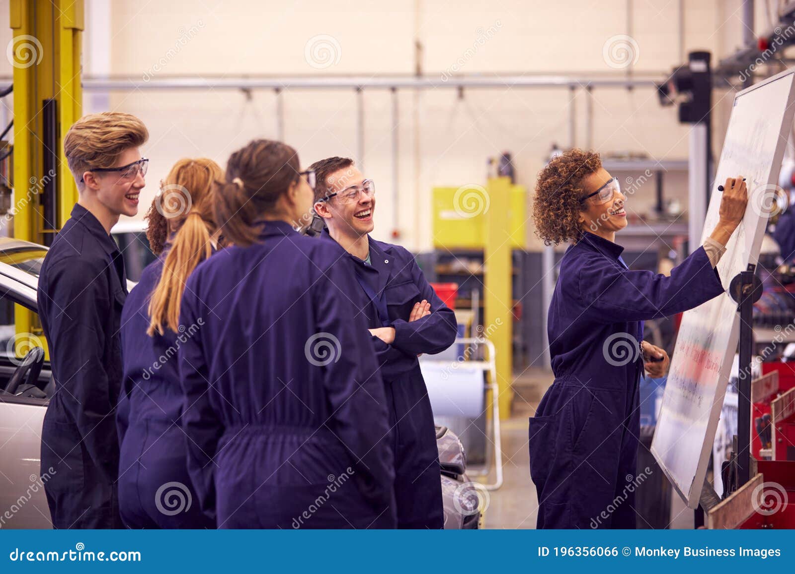 Female Tutor by Whiteboard with Students Teaching Auto Mechanic ...