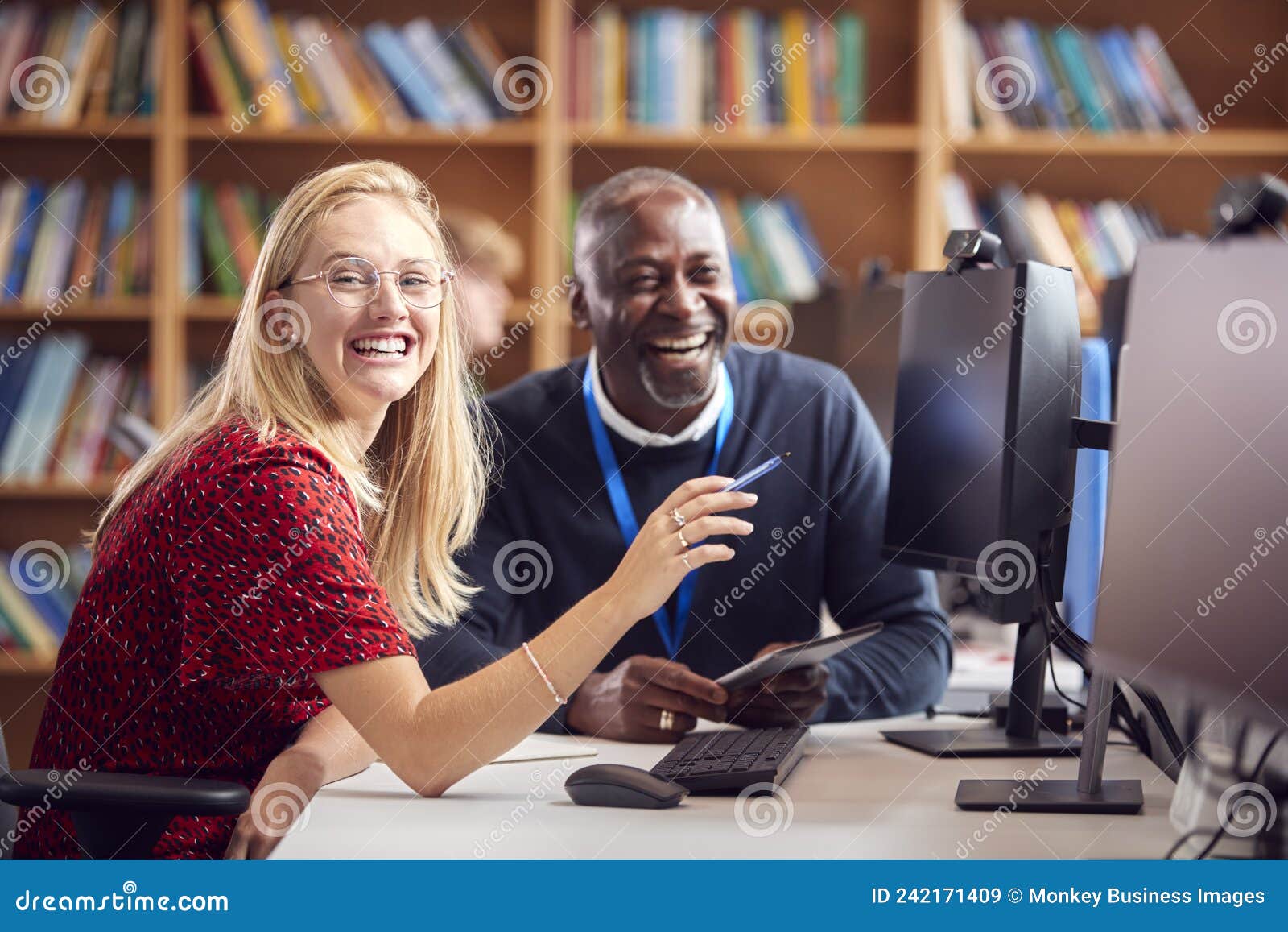 Female University or College Student Working at Computer in Library ...